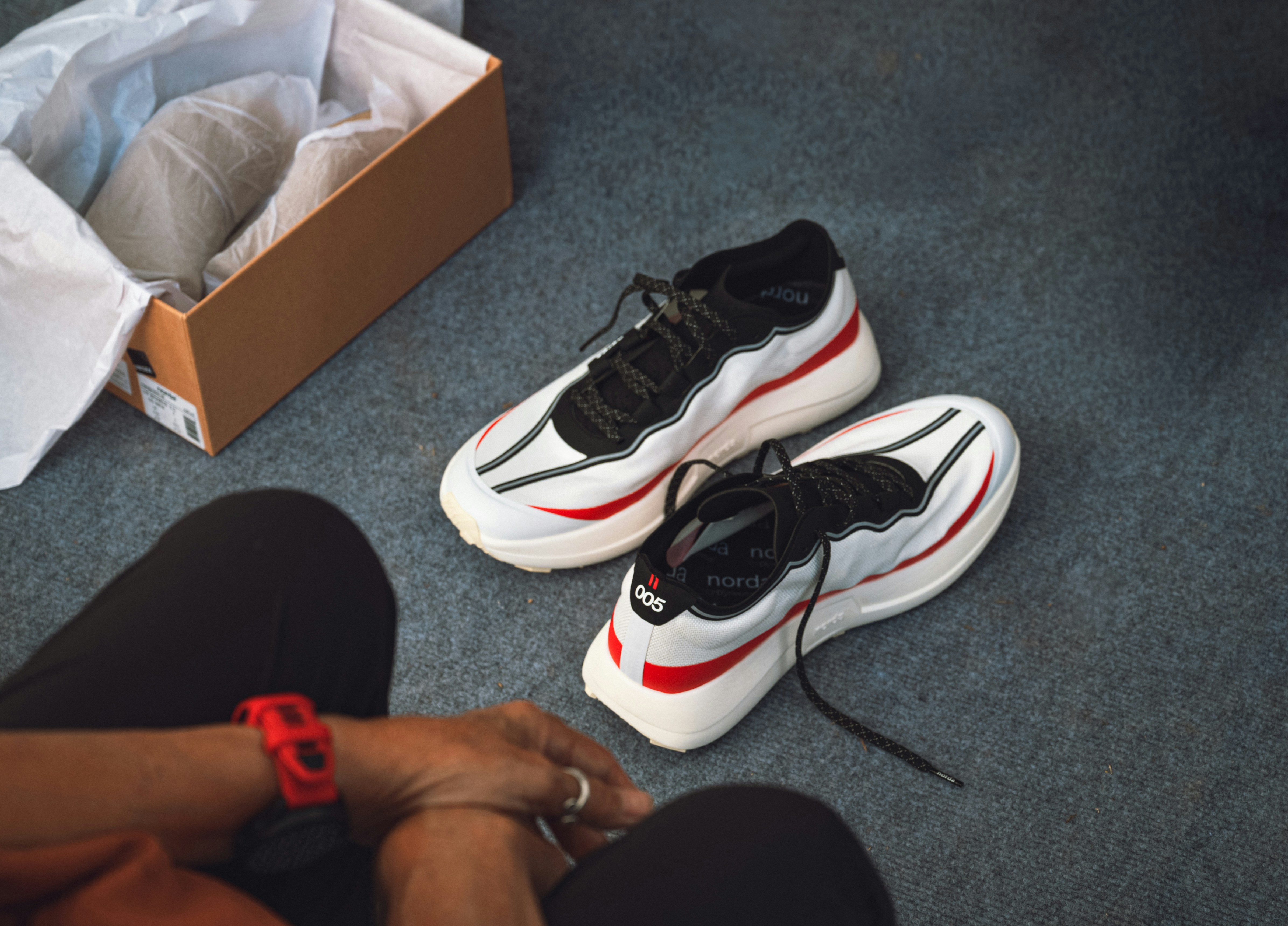 Sneaker Still Life: Duo of White-Red Runners on a Blue Carpet