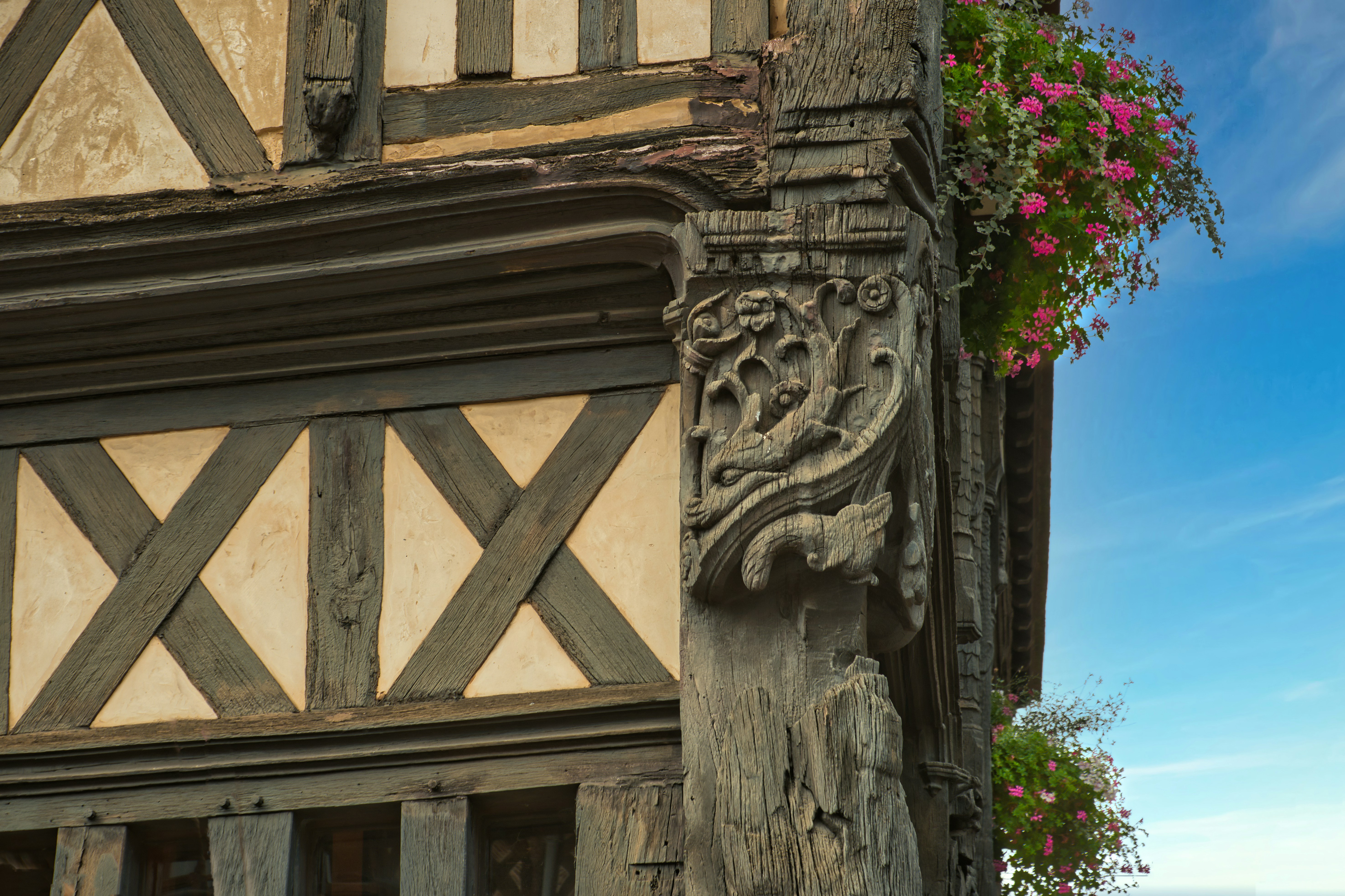 Timbered Craft: A Corner of Carved Timber and Blooming Balcony