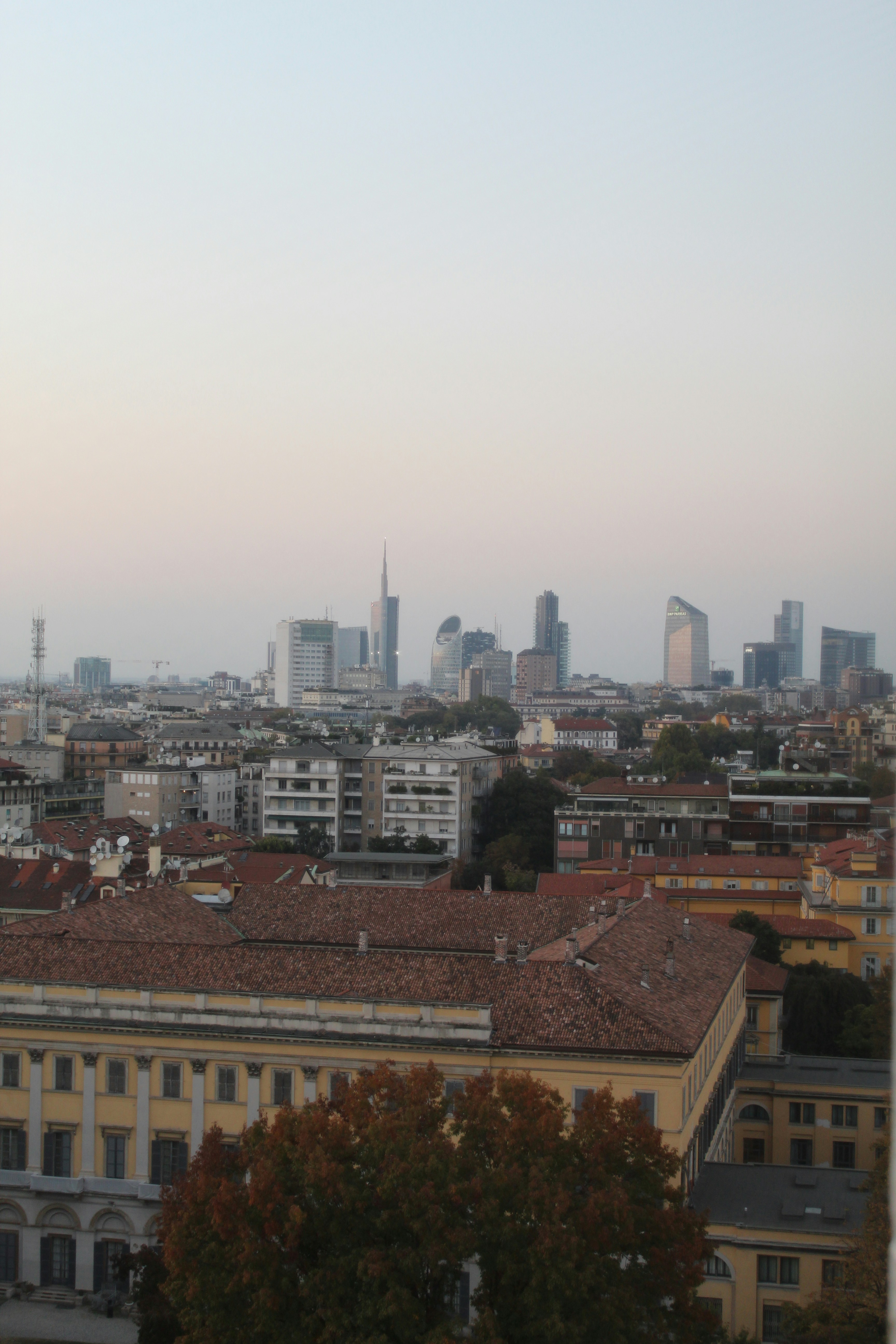 City Horizon: Rooftops Leading to a Modern Skyline at Dusk