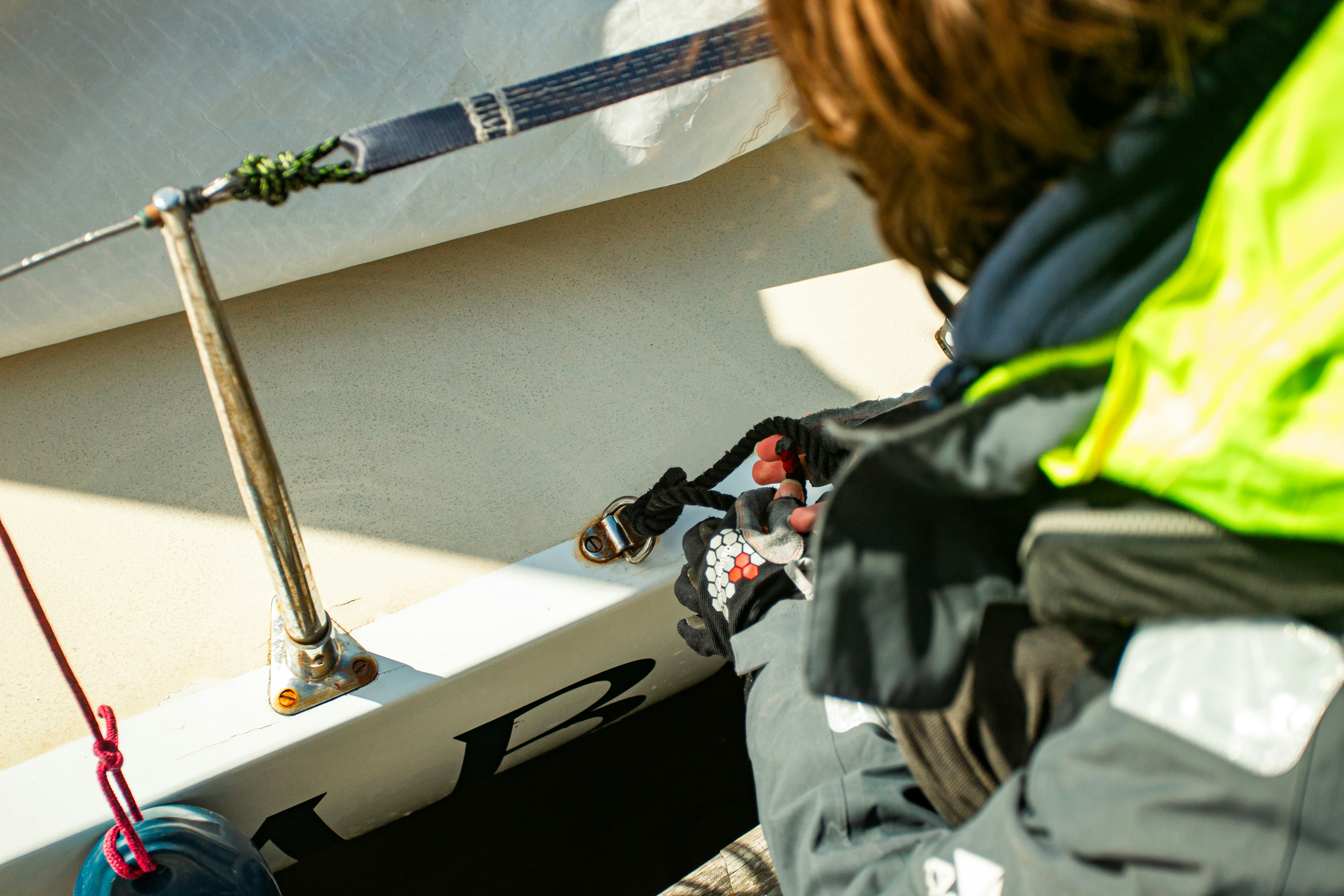 Rugged Sailor: Hand on the Rigging During a Day on the Water