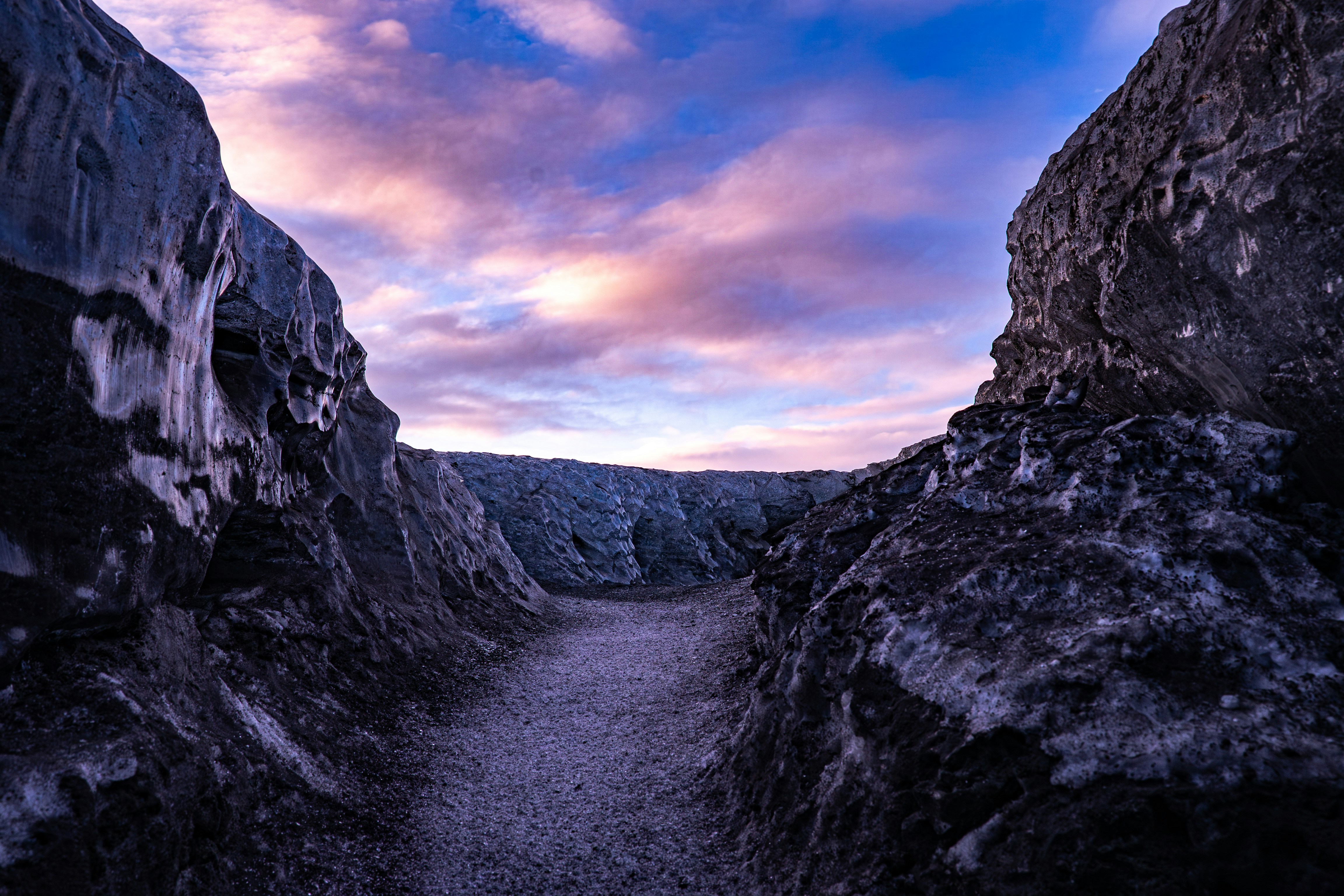 Ridge Path at Dusk: A Tunnel of Stone Beneath a Painted Sky