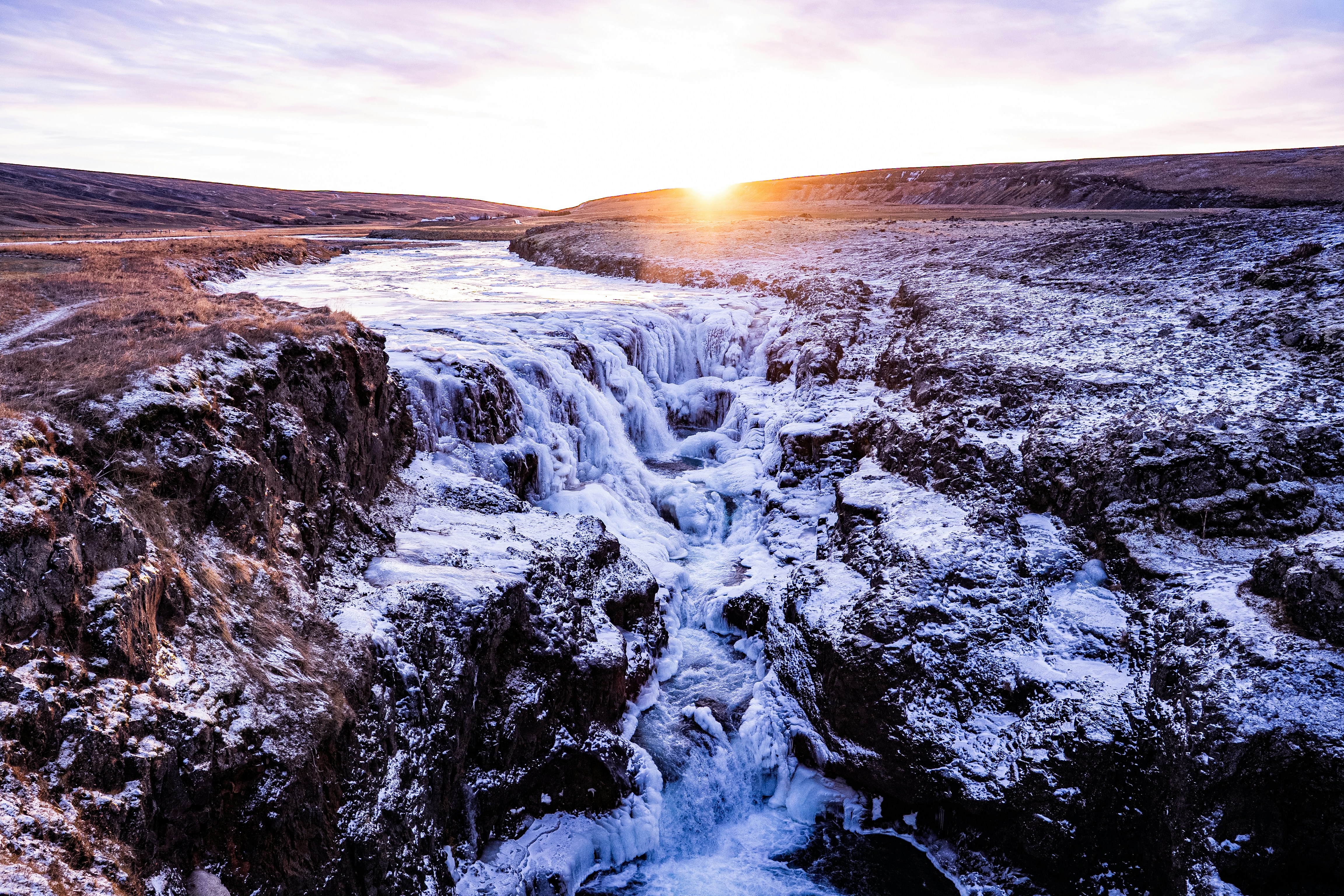 Sunlit Vortex: A Snow-Fringed Gorge at Dusk
