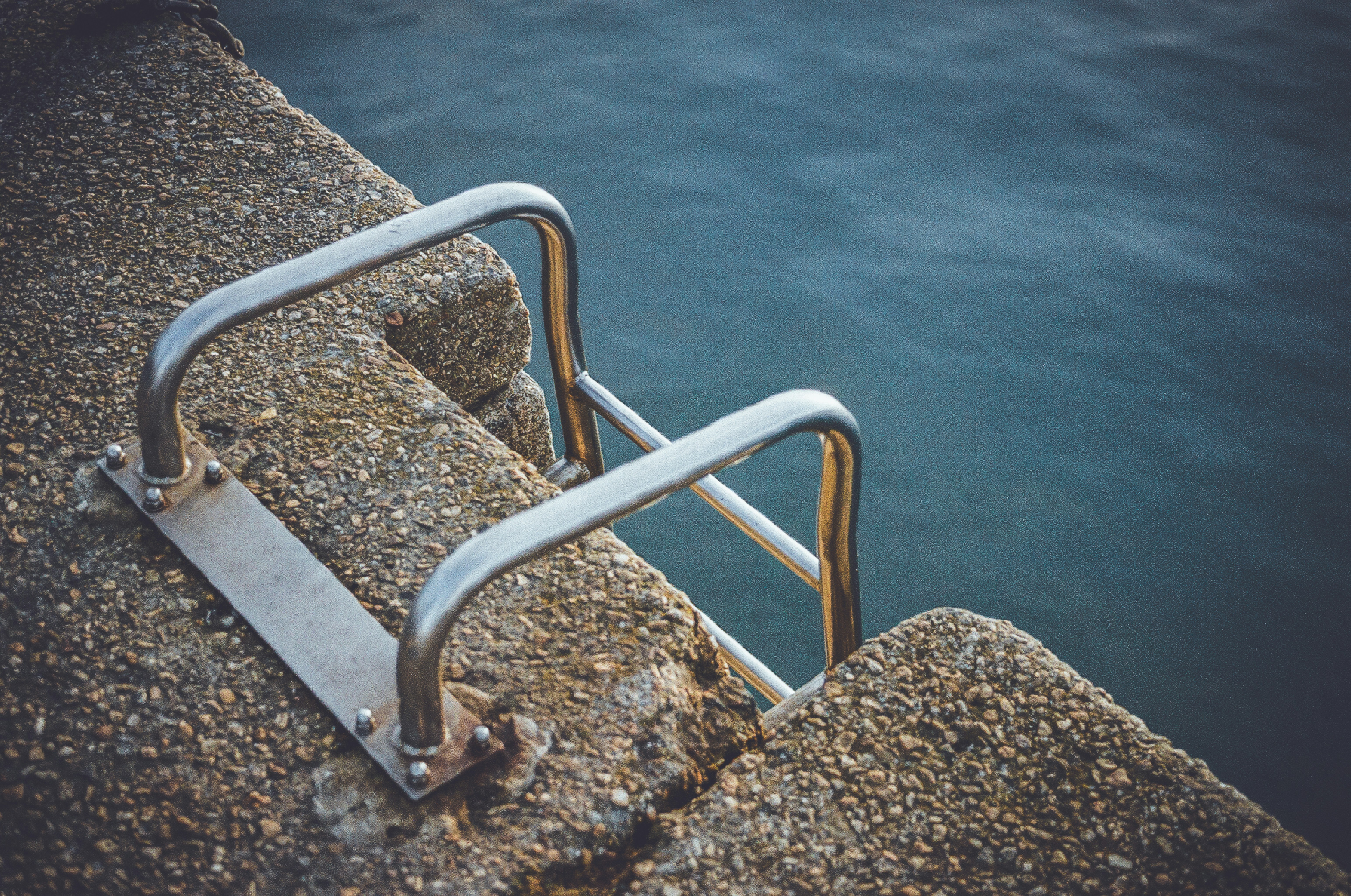Rusted Handrails Descend into the Quiet Sea