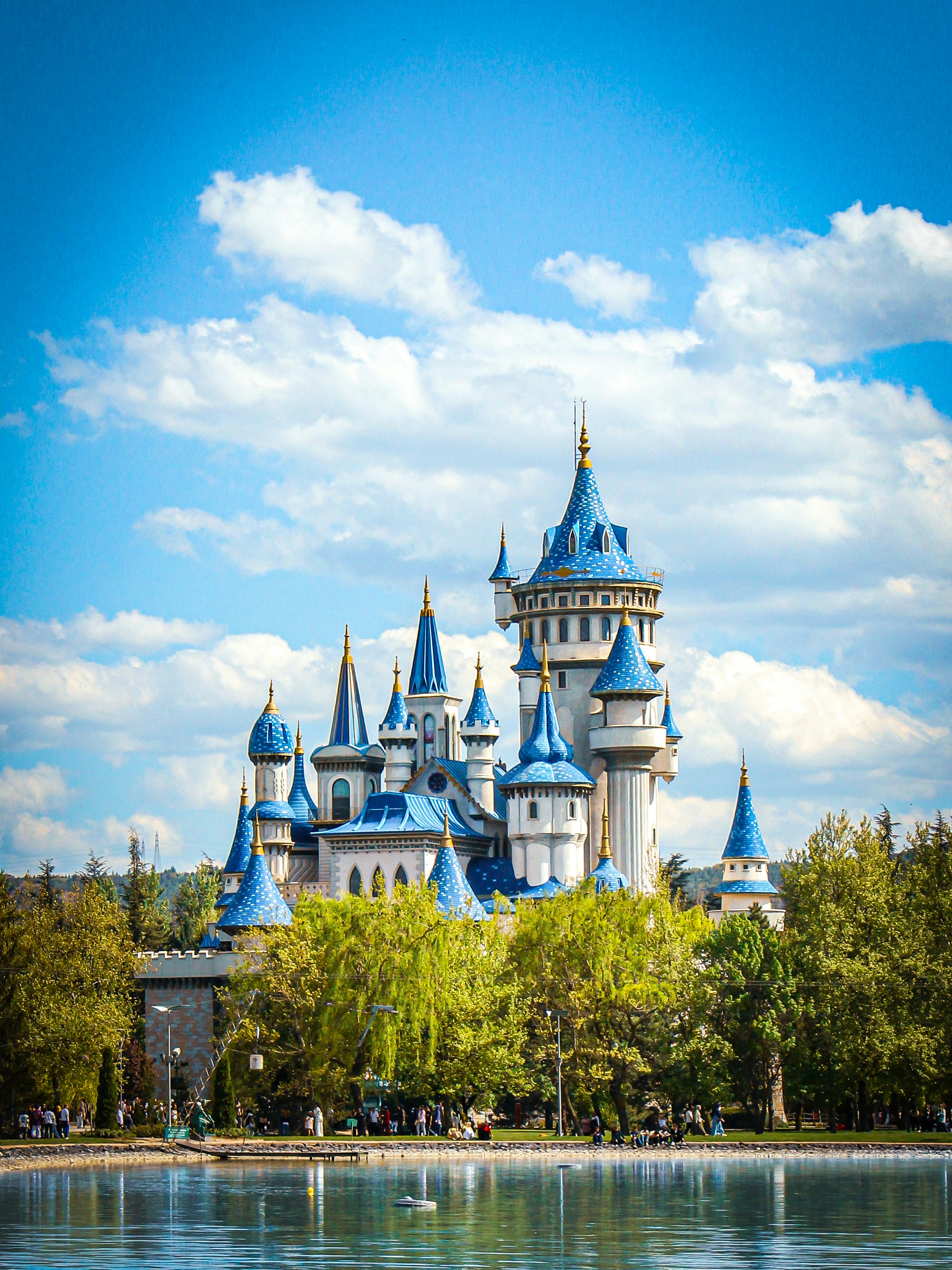 Blue-topped Fantasy: A Castle Arising Over Green Canopy