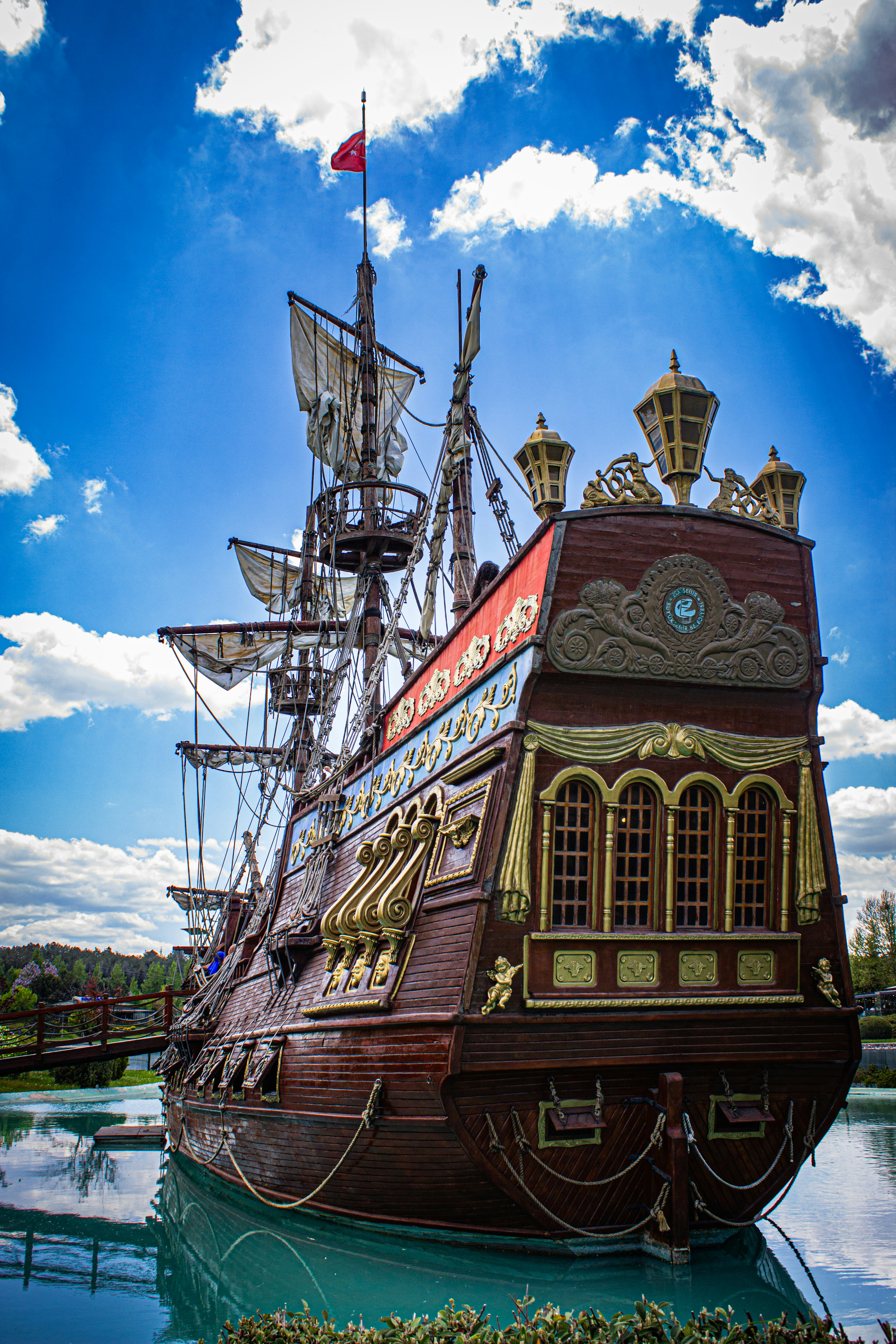 Voyage at Dusk: The Wooden Galleon on Glassy Waters