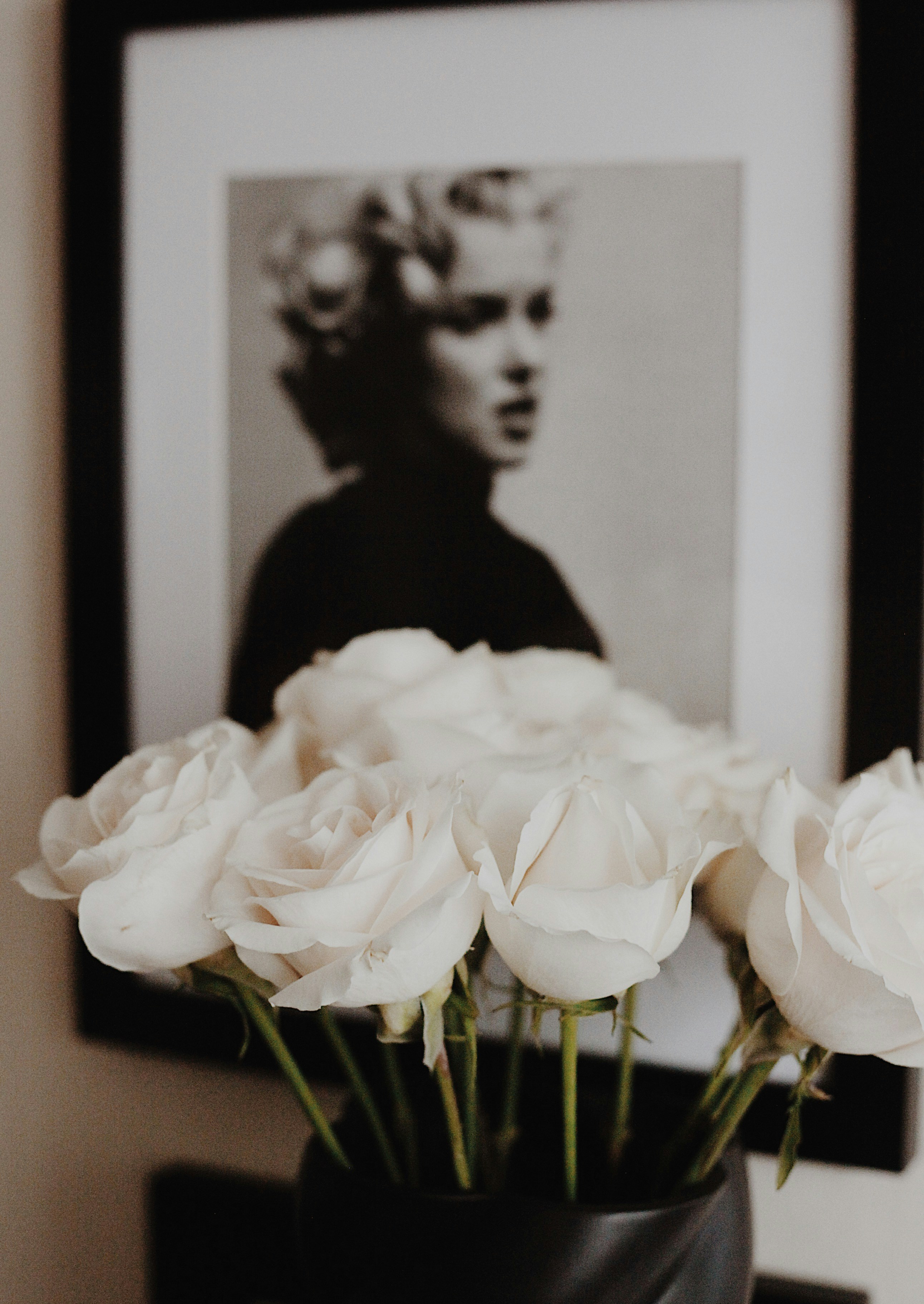 White Roses in Front of a Portrait