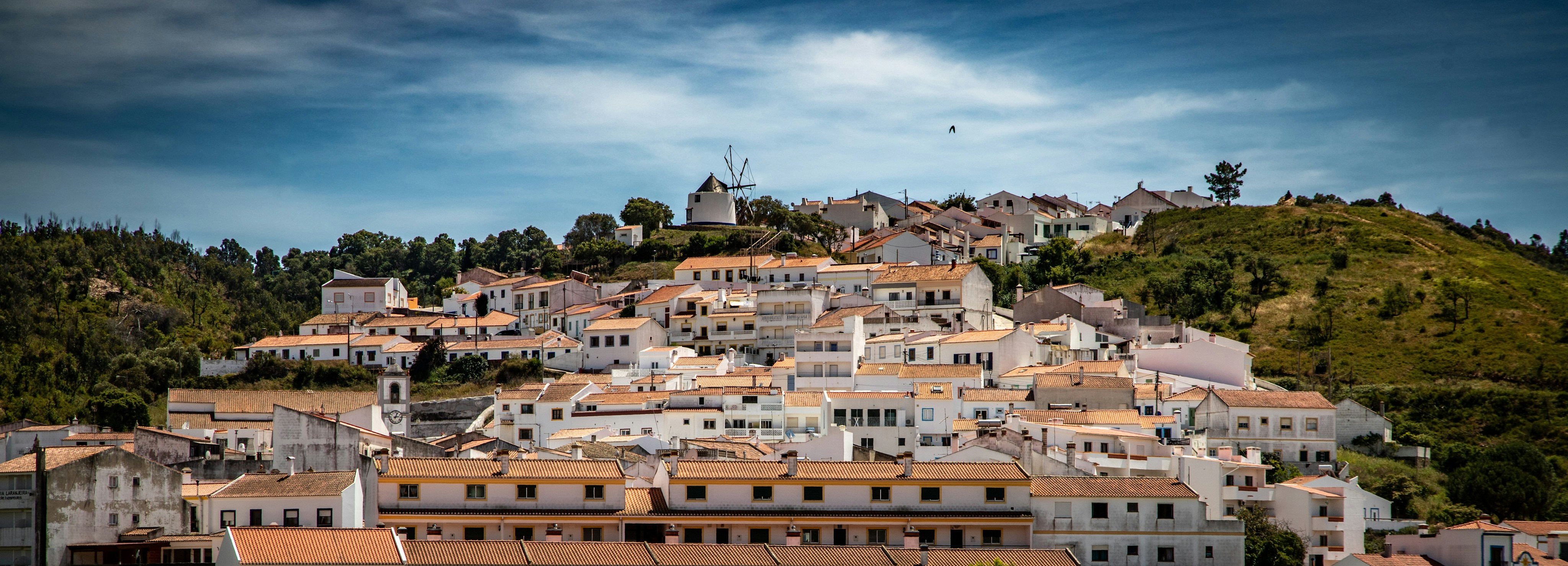 Terraced village crown: white-washed houses climbing a sunlit hill