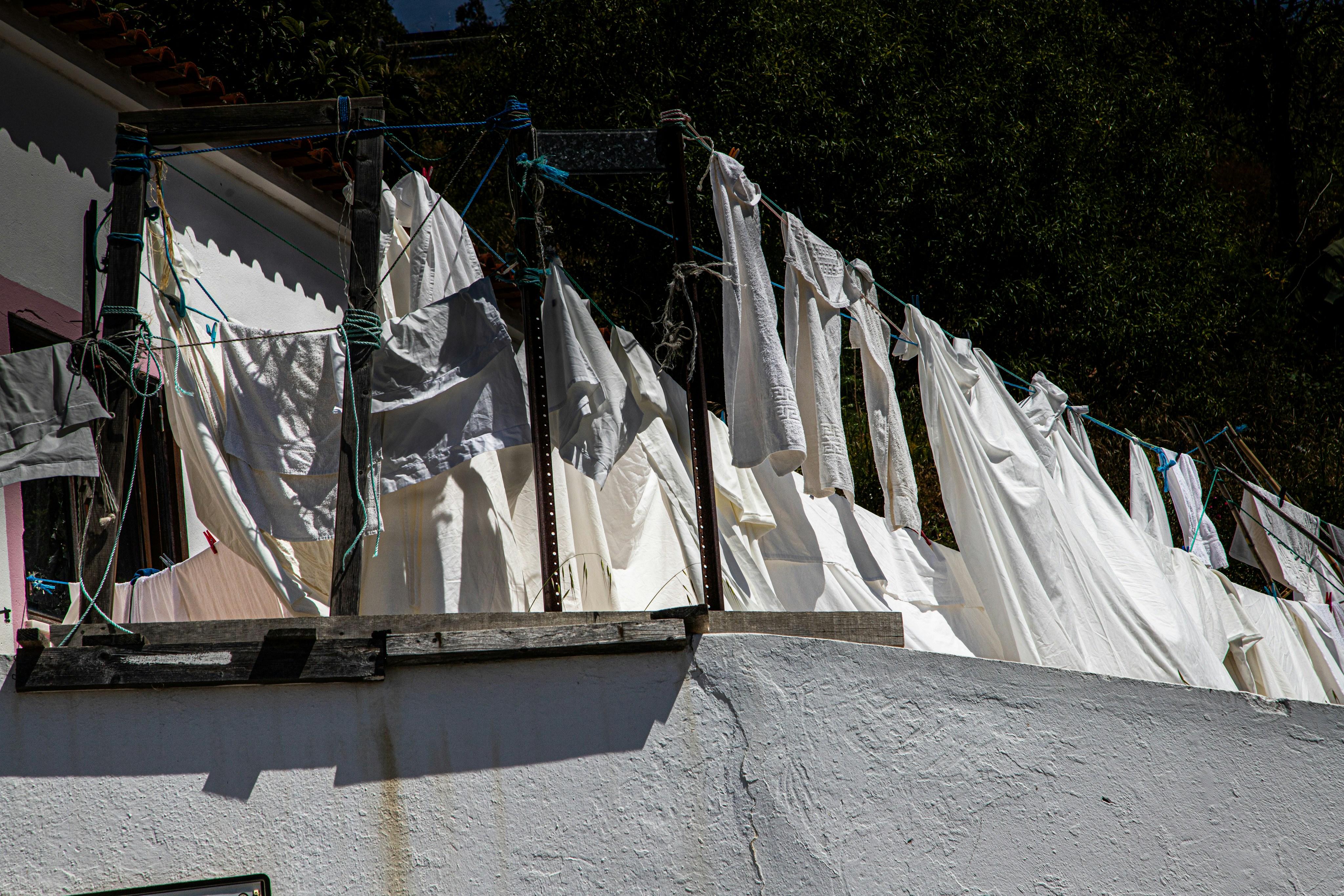Lines of Laundry Against a Sunlit Railing