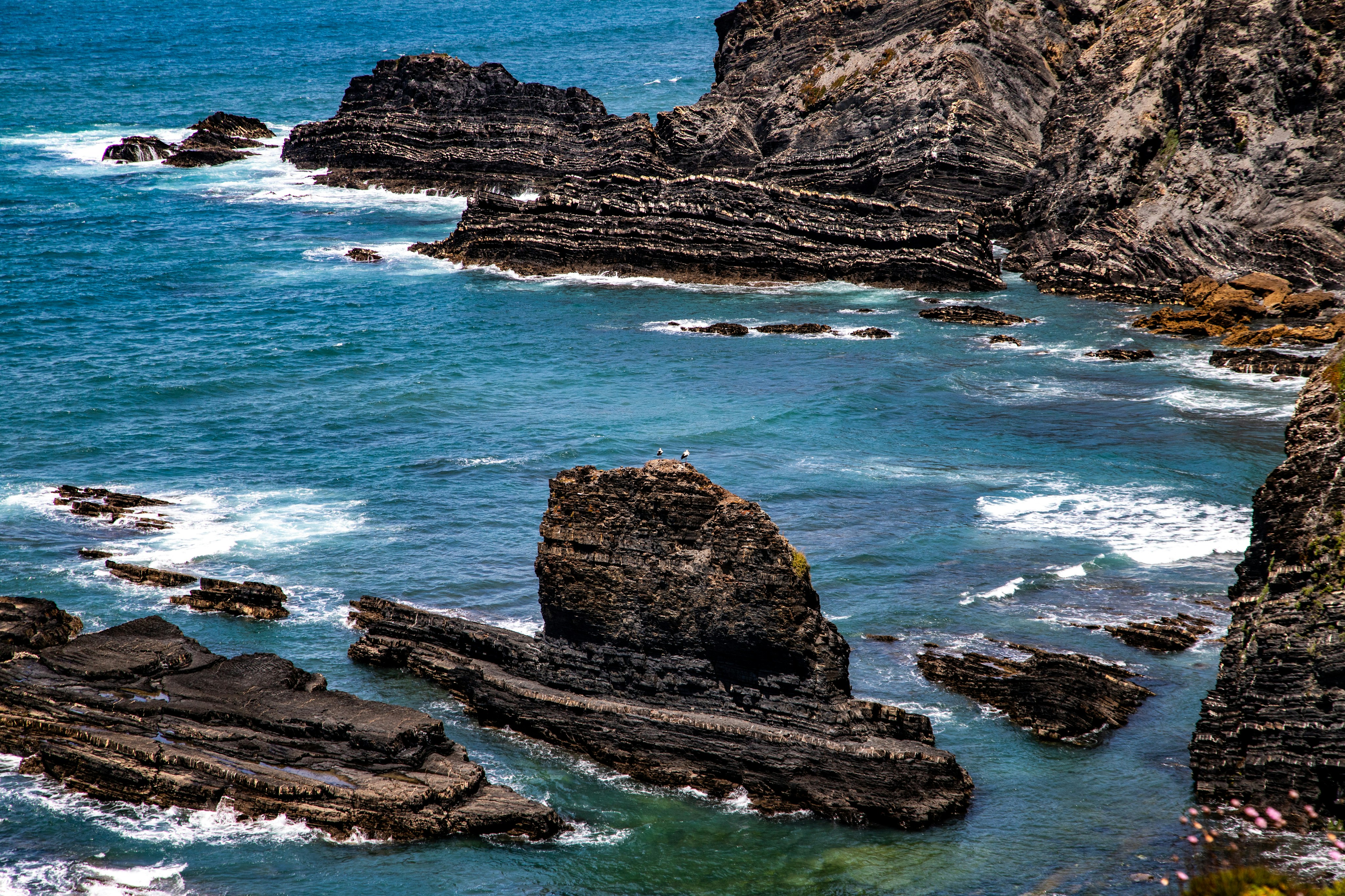 Tide-Worn Promontory: Rugged Rocks Meet Azure Waves