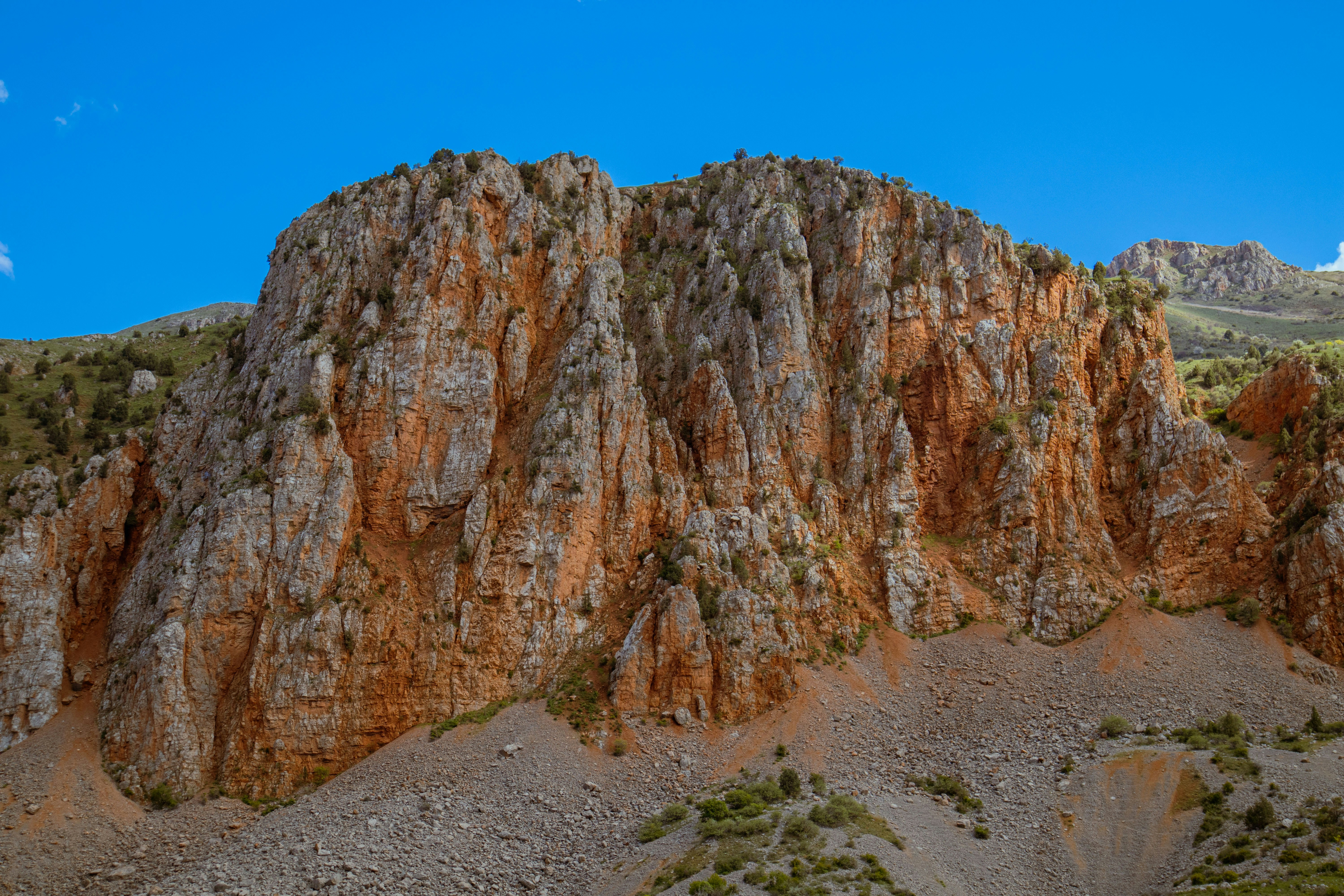 Rugged Prominence: A Canyon Wall Rising Above a Gravel Slope