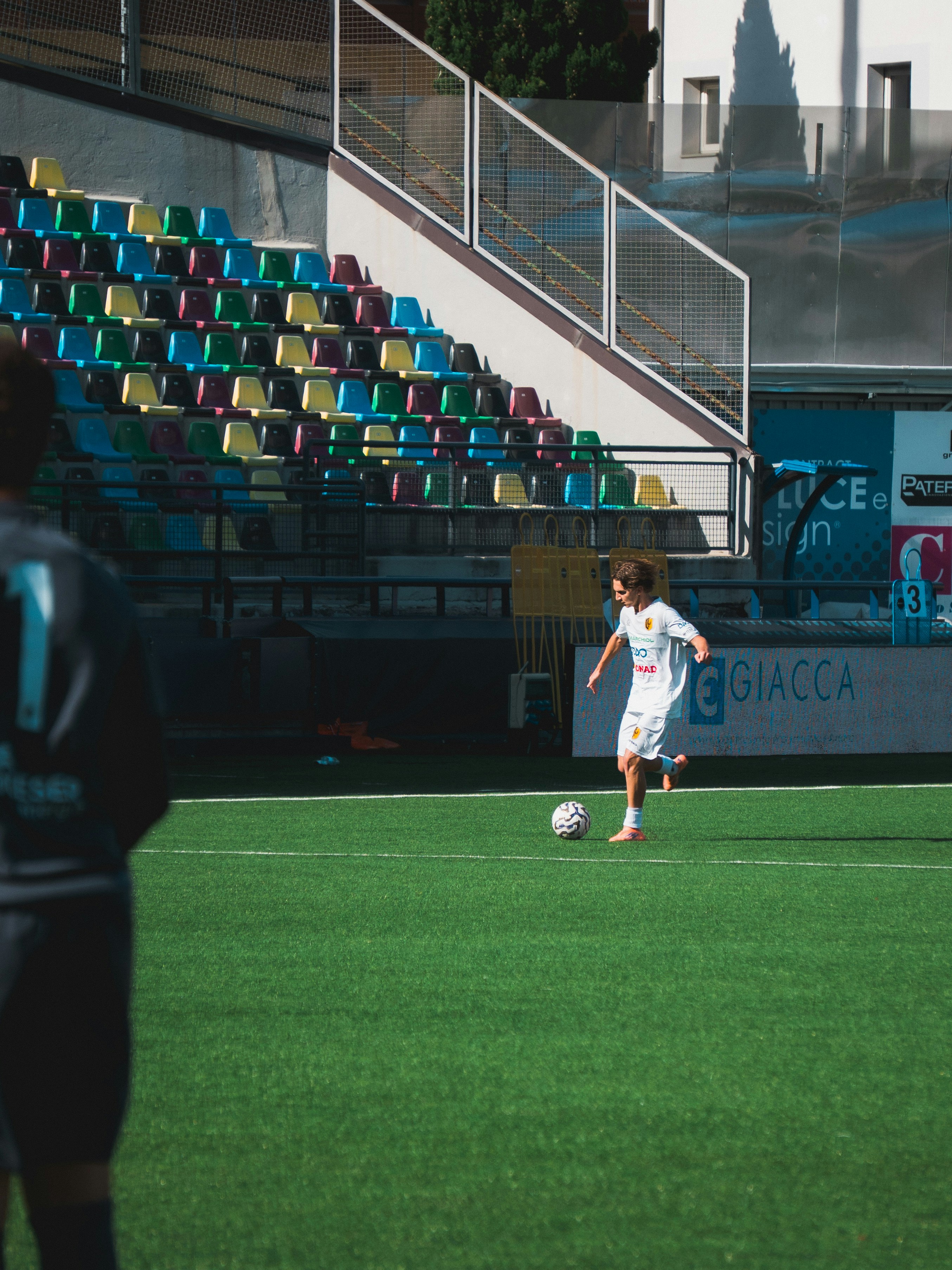 Youth Soccer Moment: The Ball at the Player's Feet on a Sunlit Pitch