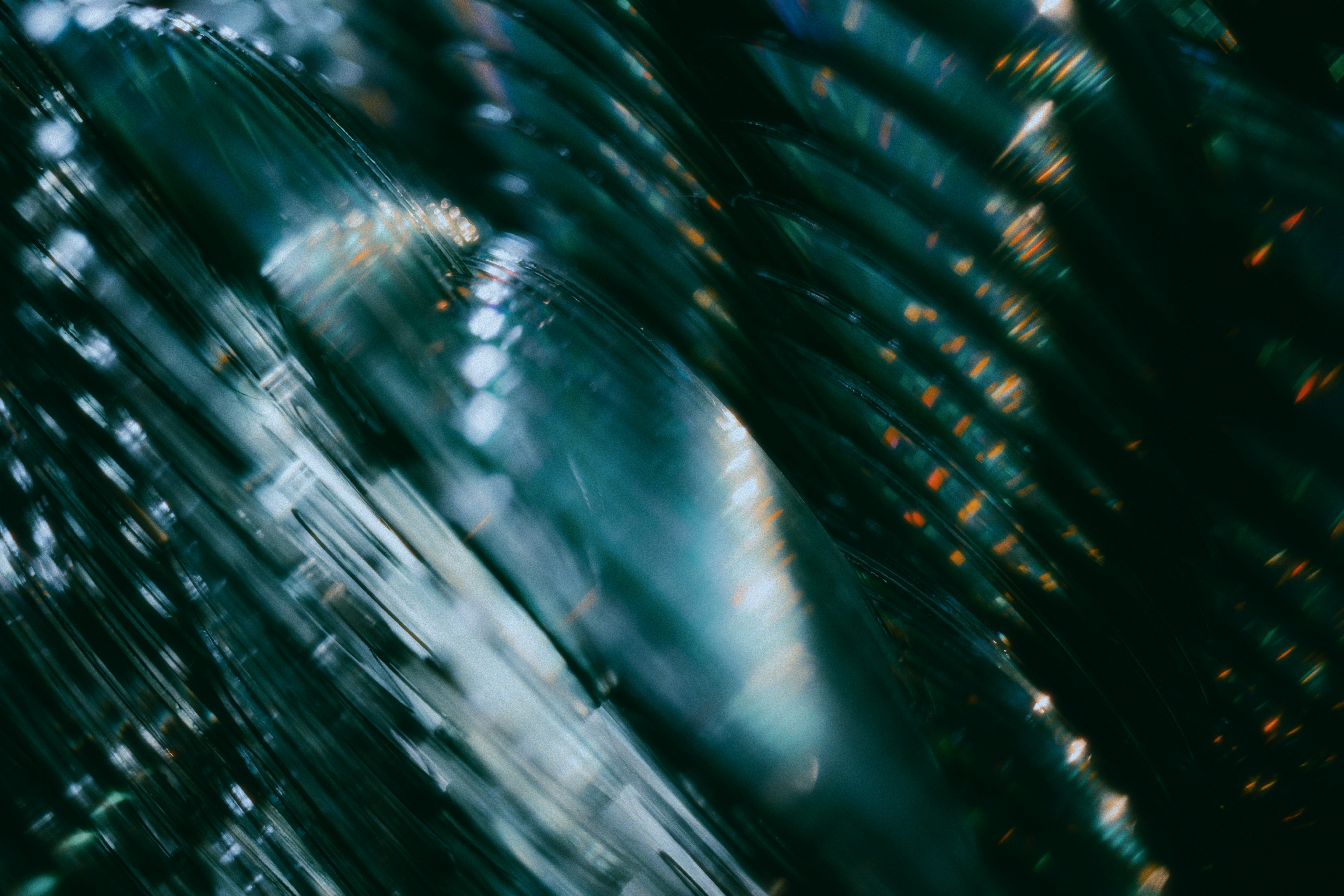 Fractured teal light ribbons in motion