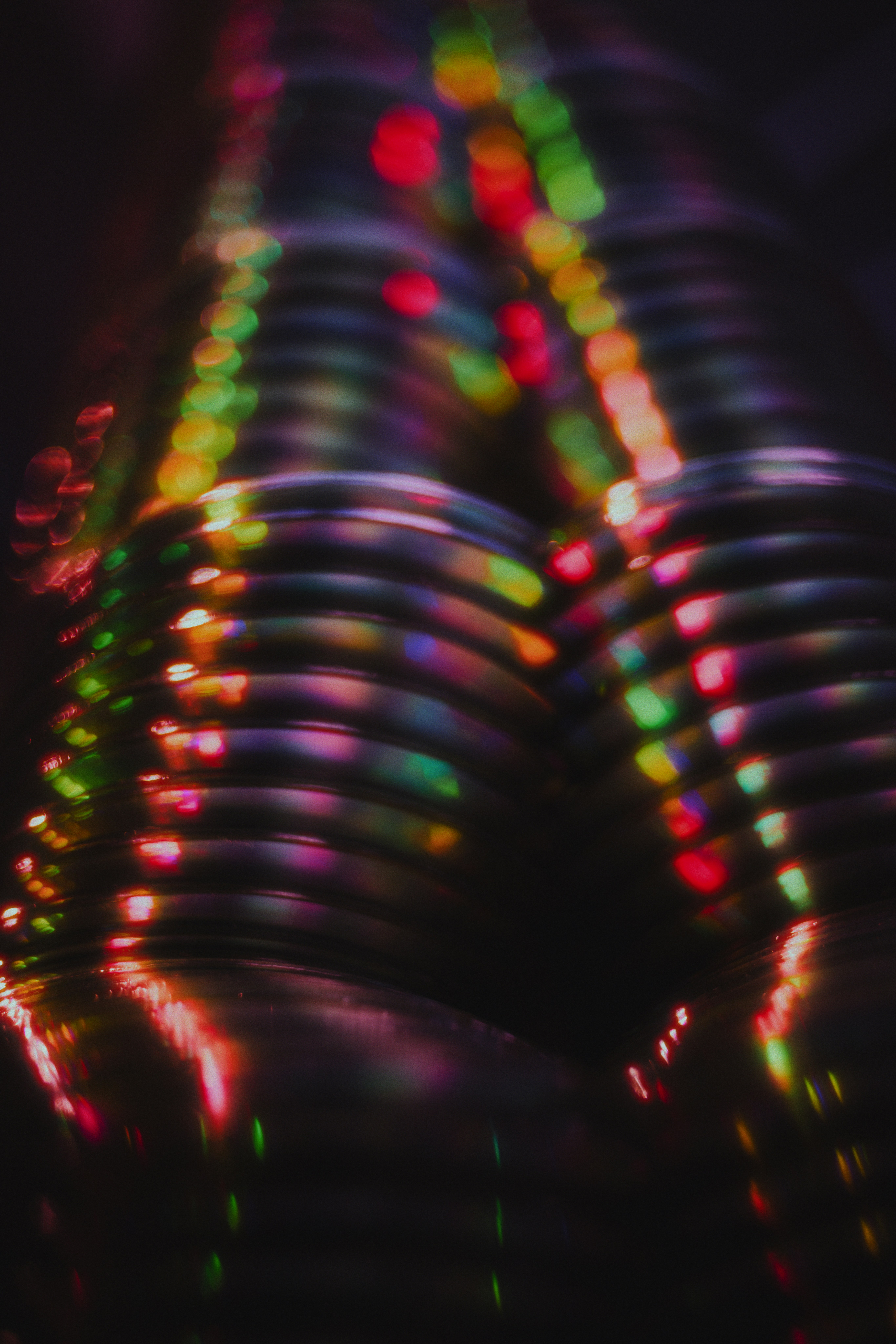 Neon Spiral Reflections: Abstract Light Ribbons on Dark Glass