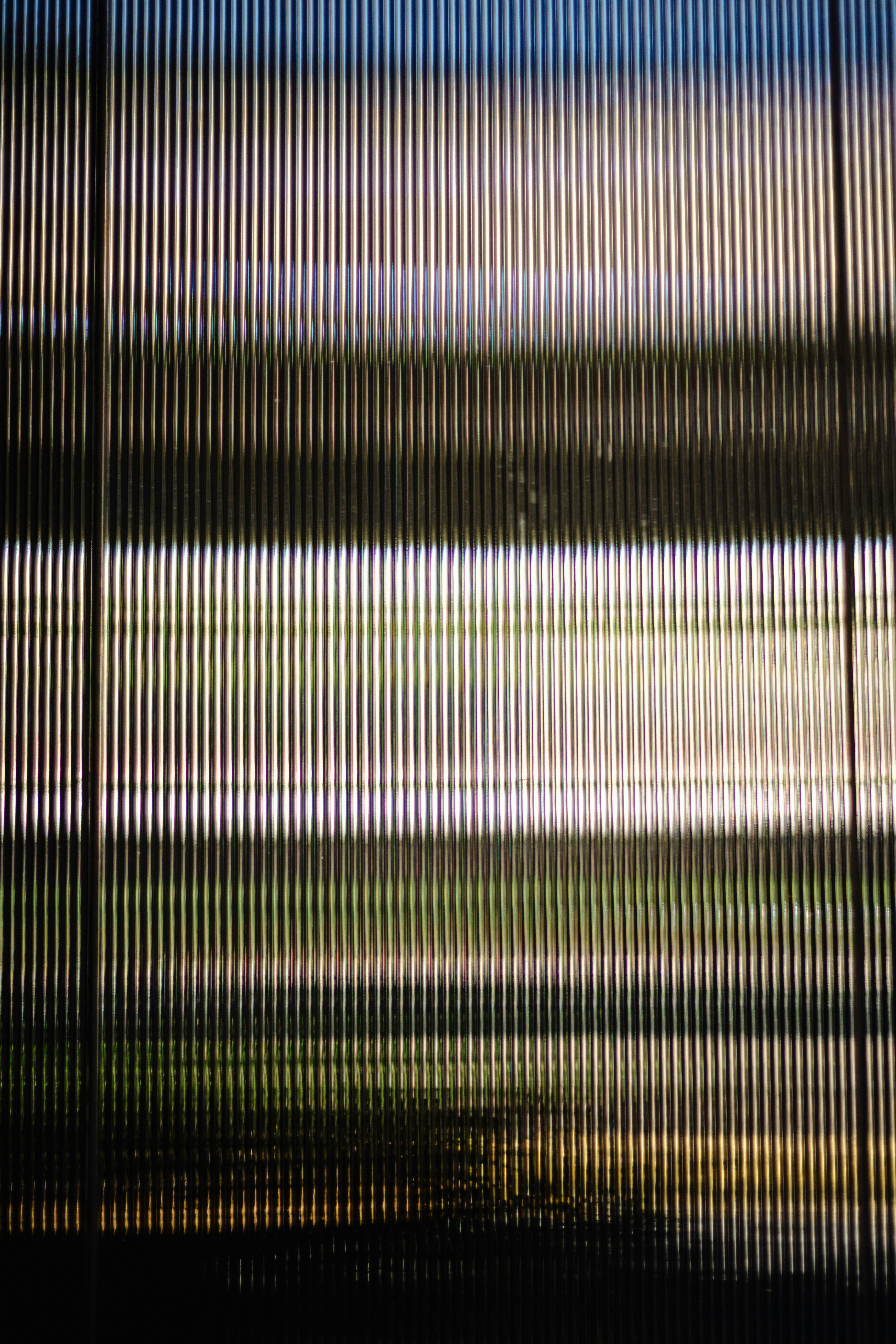 Shadowed Striations: Light Through a Ribbed Barrier