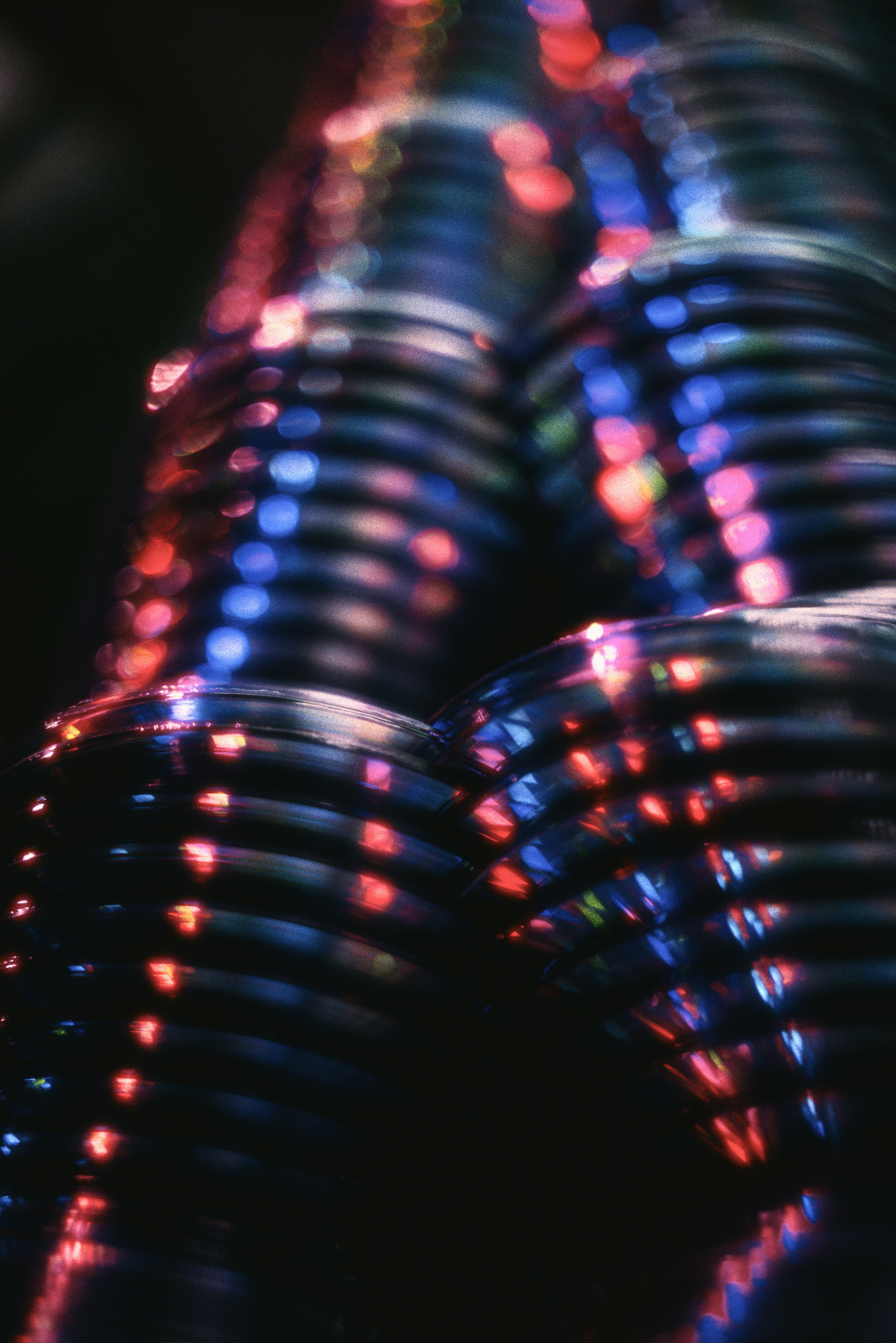 Neon Coil Symphony: Shimmering Cylinders in Quiet Blur