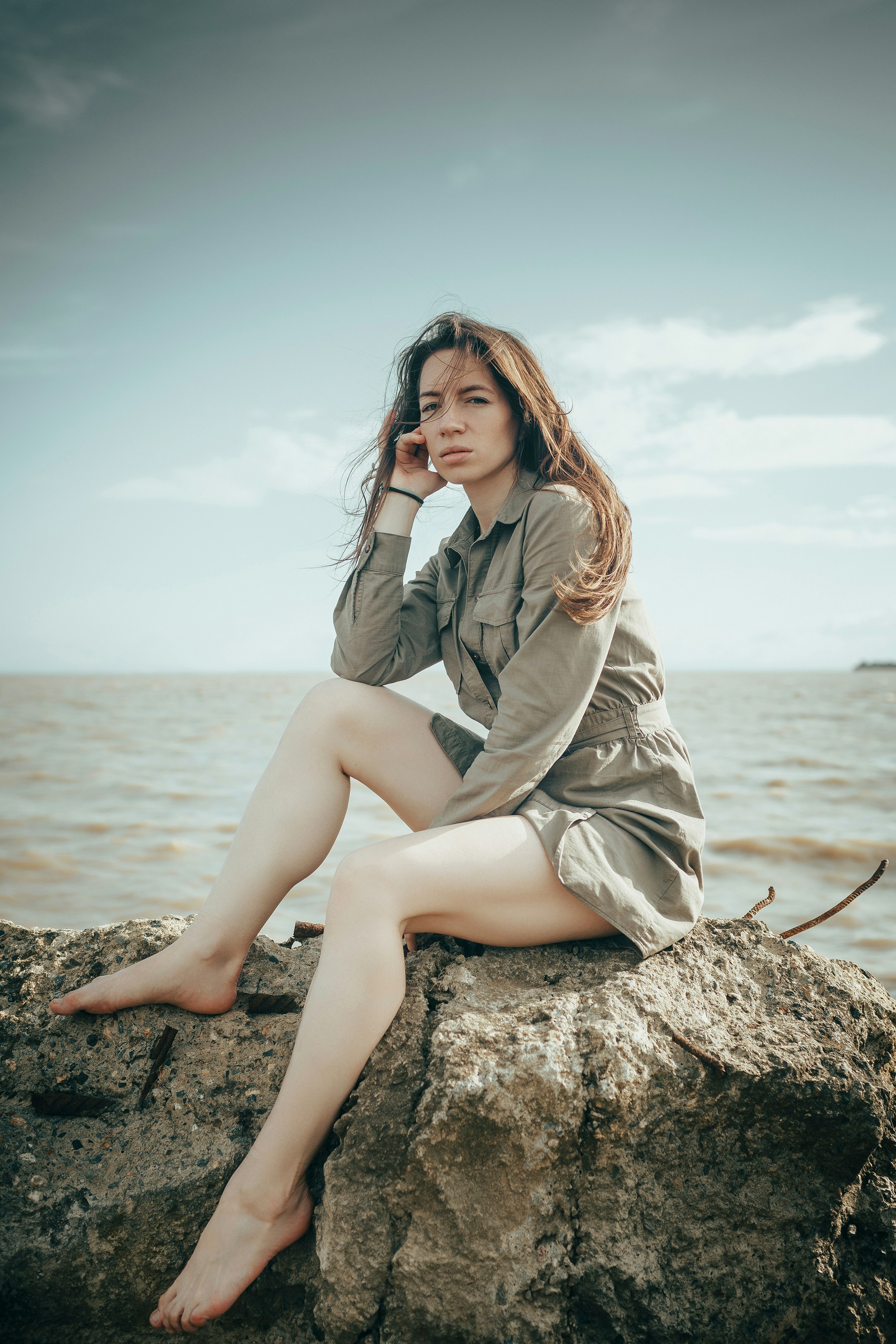 Coastal Gaze: A Quiet Moment on the Rocks