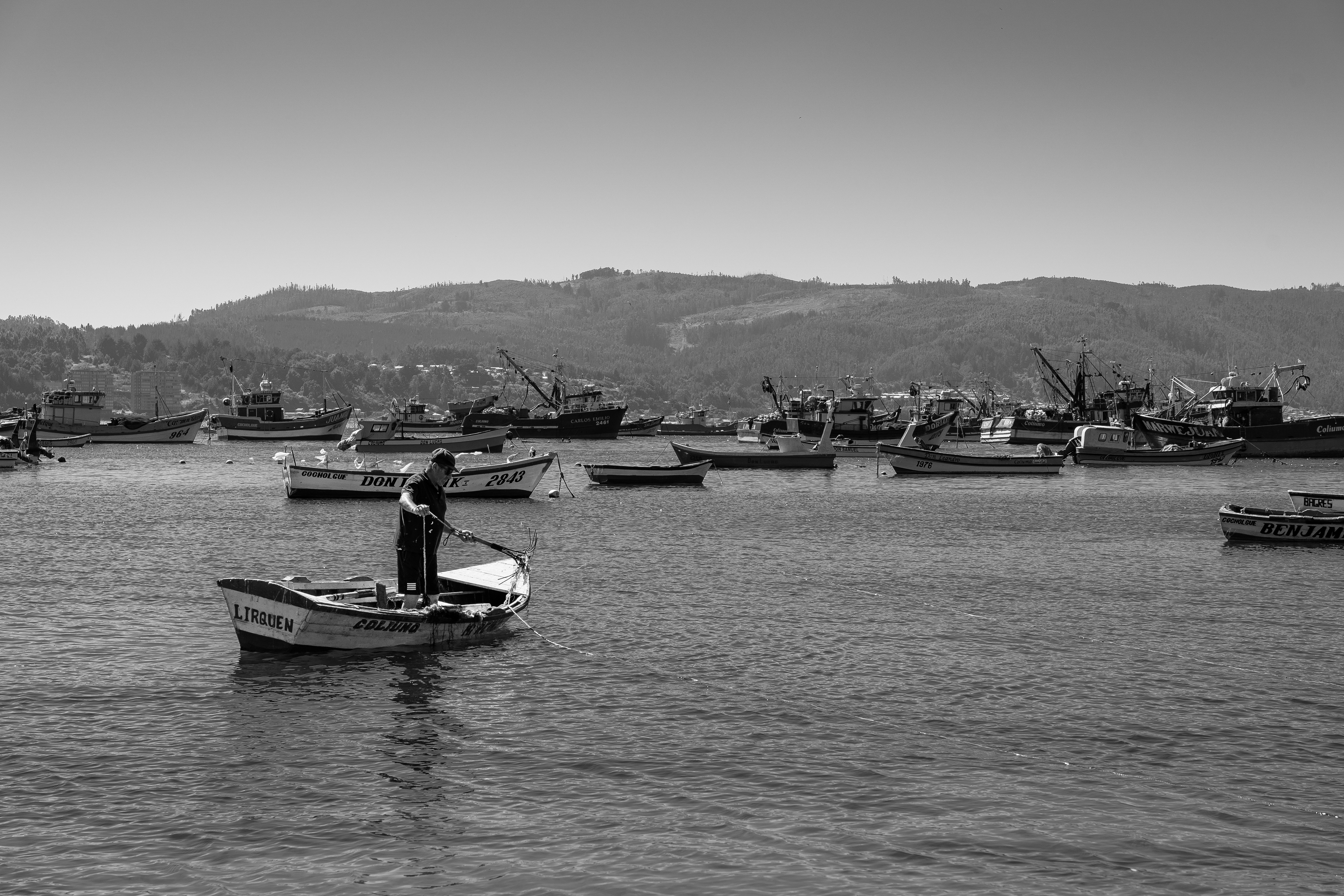 Silent Harbor: A Lone Boat Skims the Distant Calm
