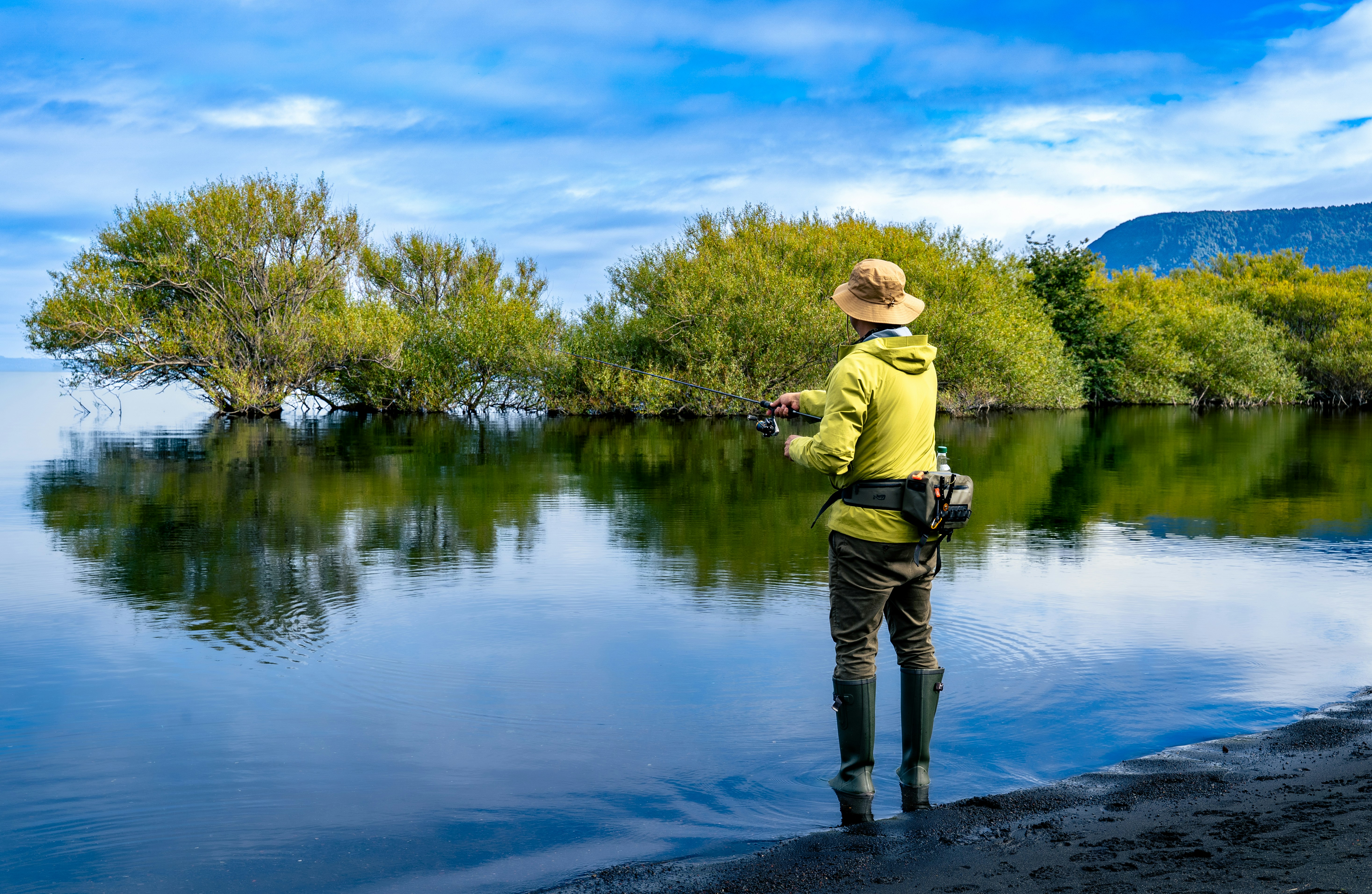 Line in the Stillness: A Fisherman Beside a Quiet River