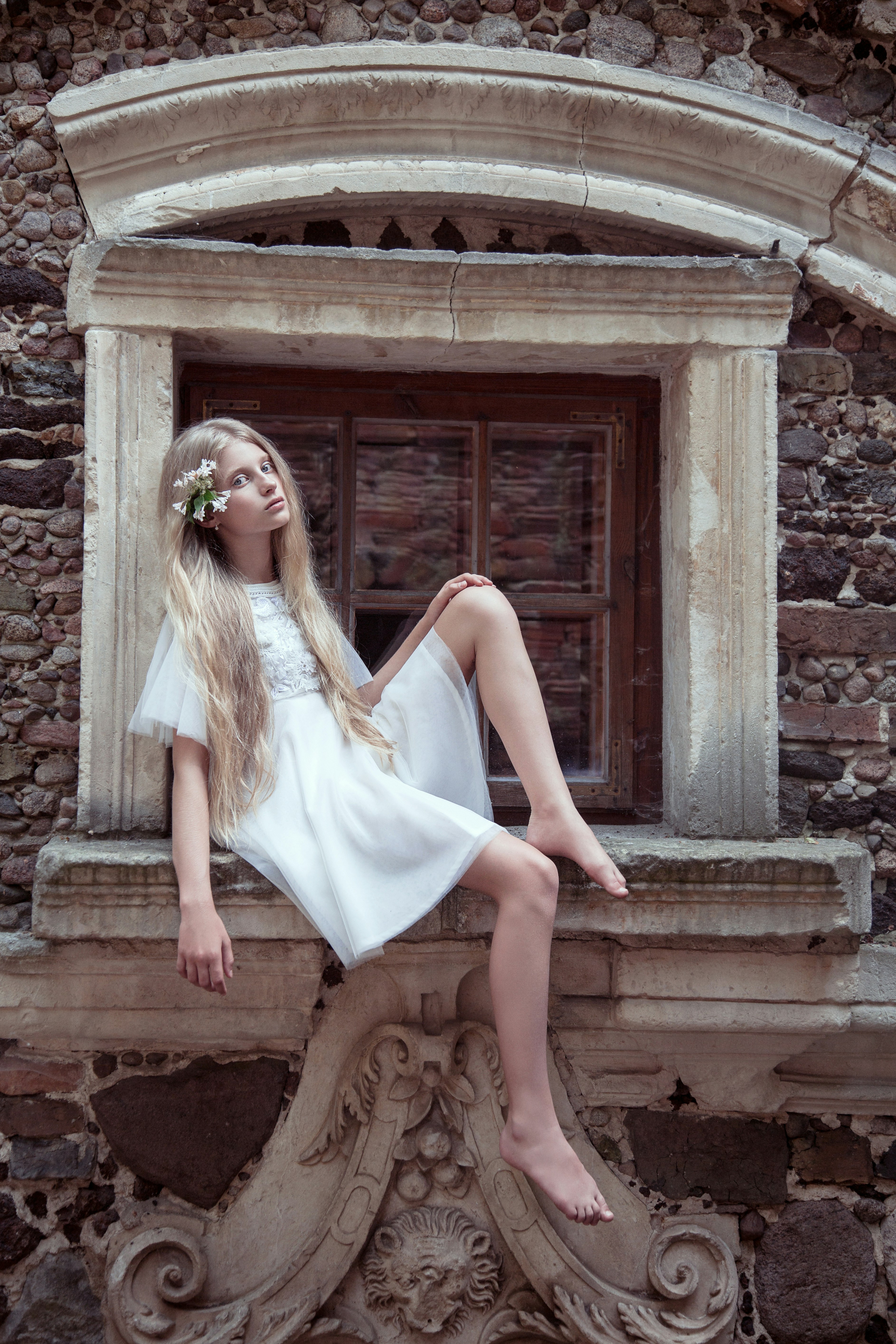 Grace on Stone: A White Dress Against Timeworn Architecture