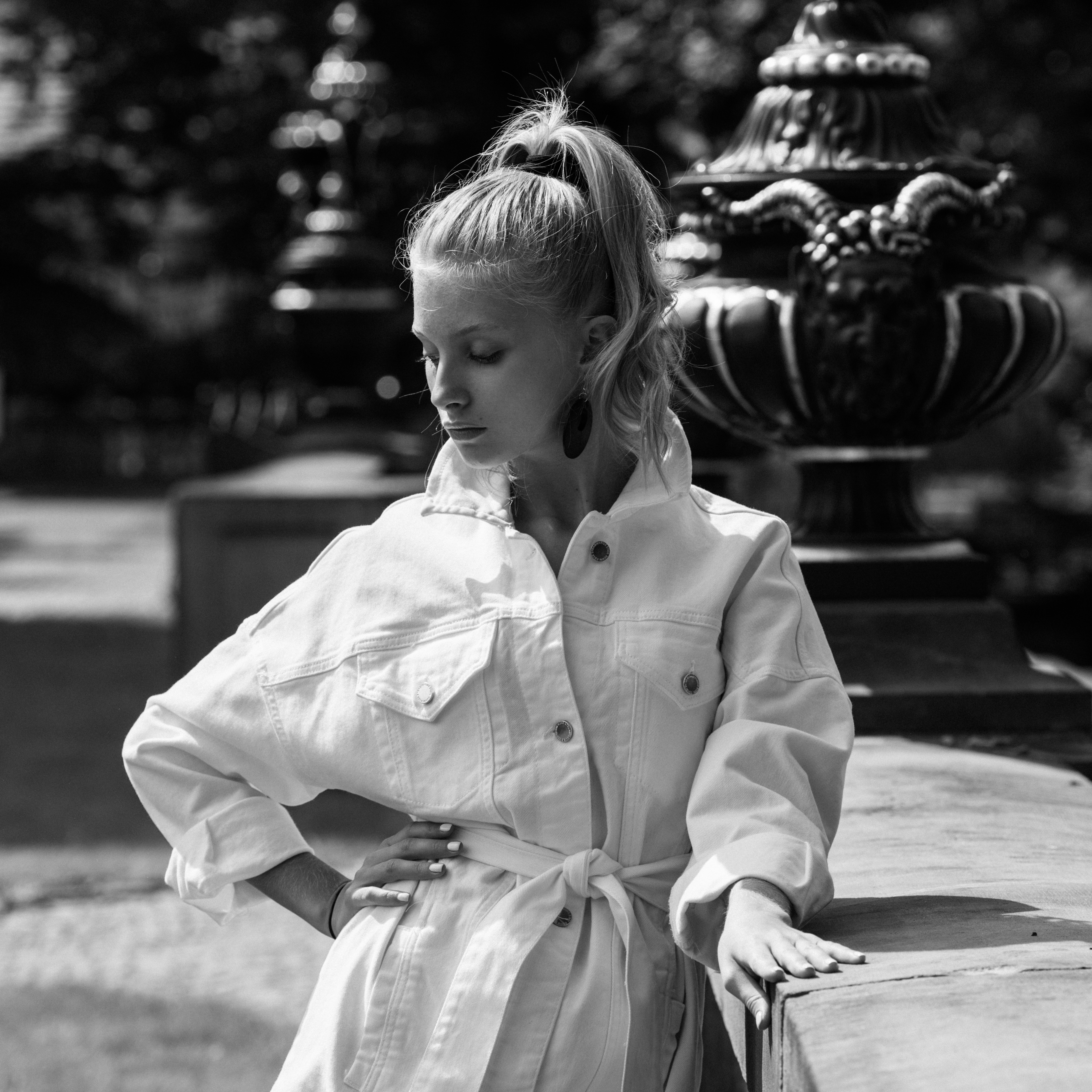 White Jacket, Quiet Confidence: A Portrait by the Fountain