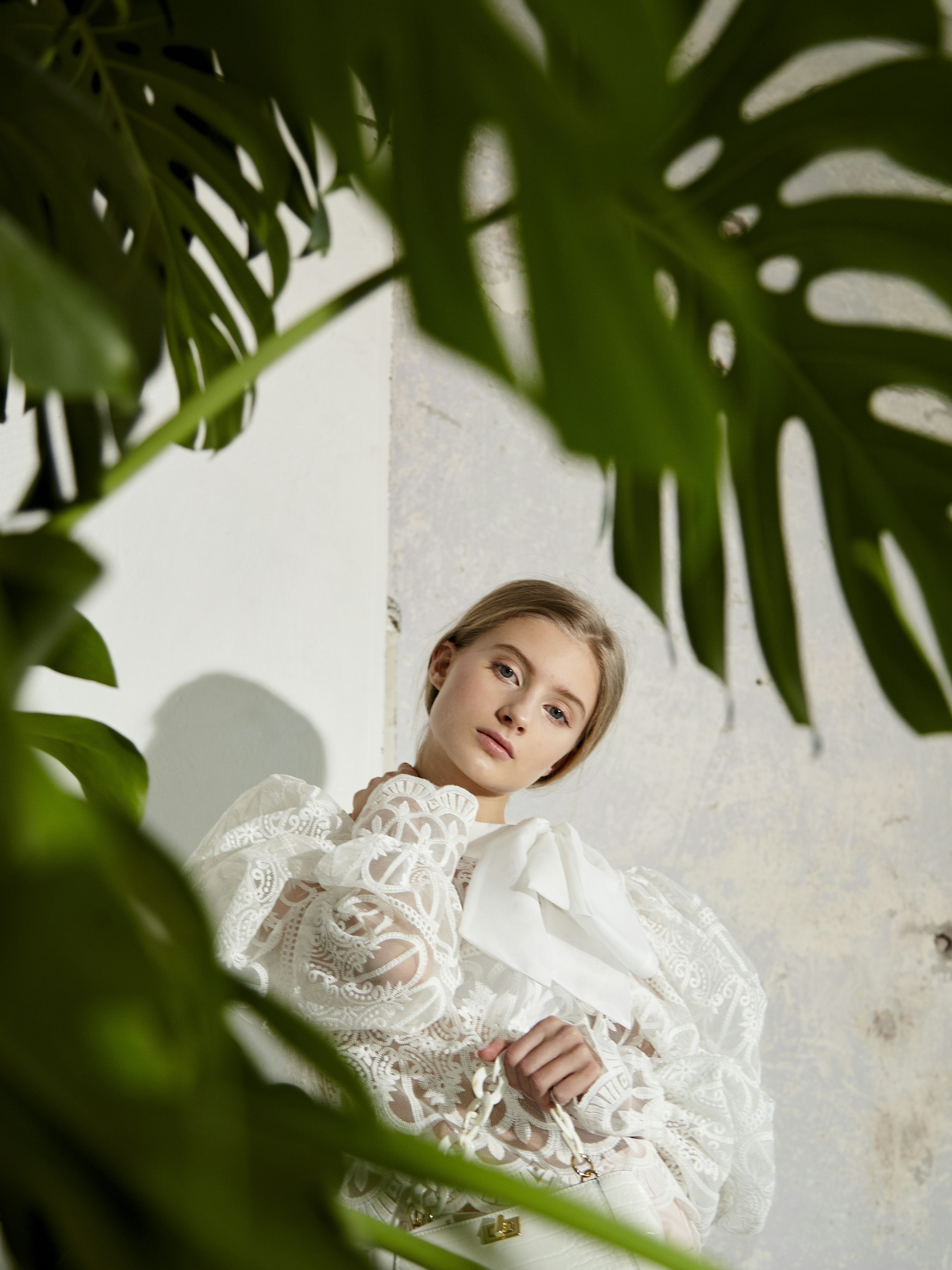 Lace and Light: A Portrait Framed by Tropical Foliage