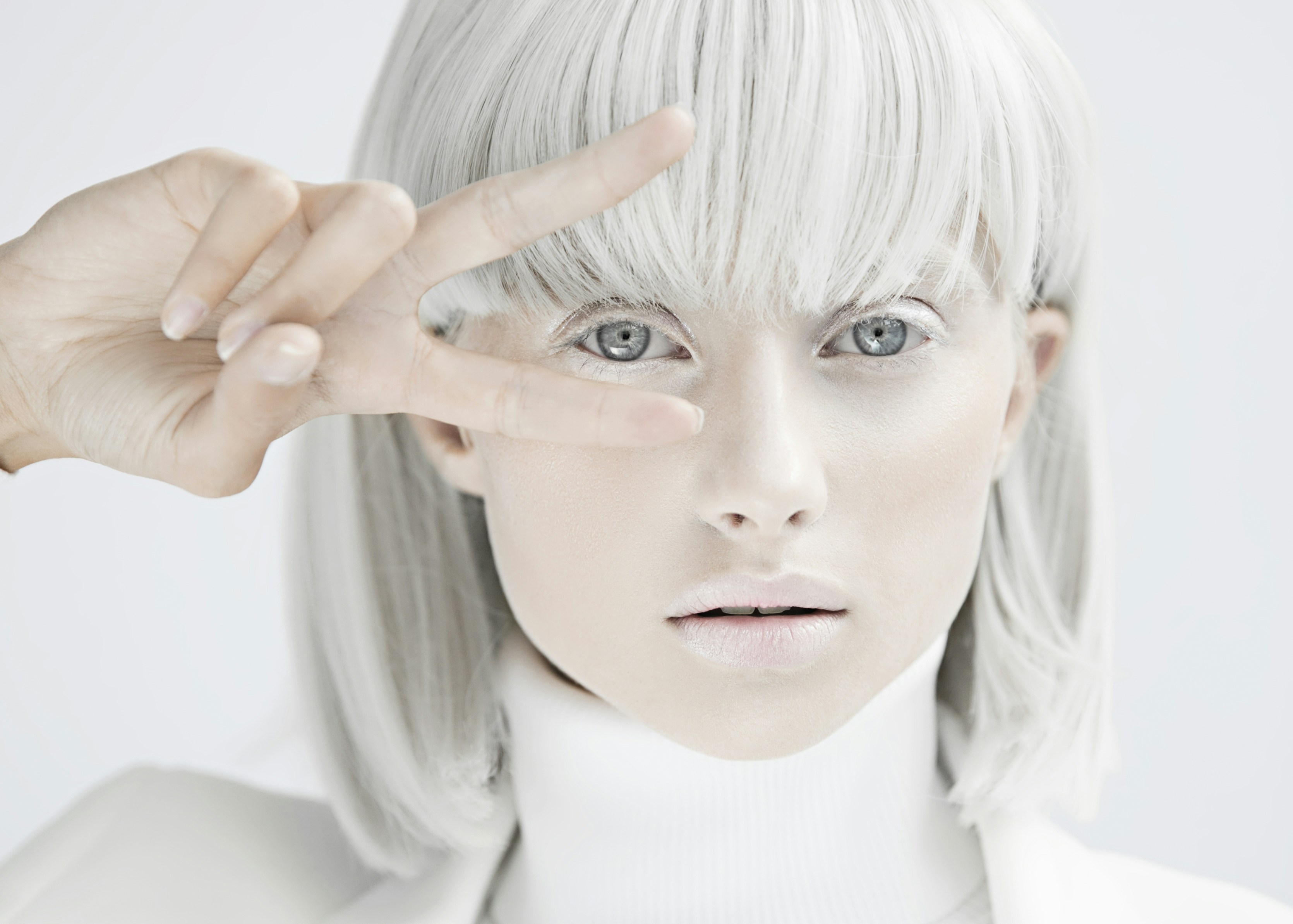 Ghostly Glimpse: pale portrait with a half-gesture pose