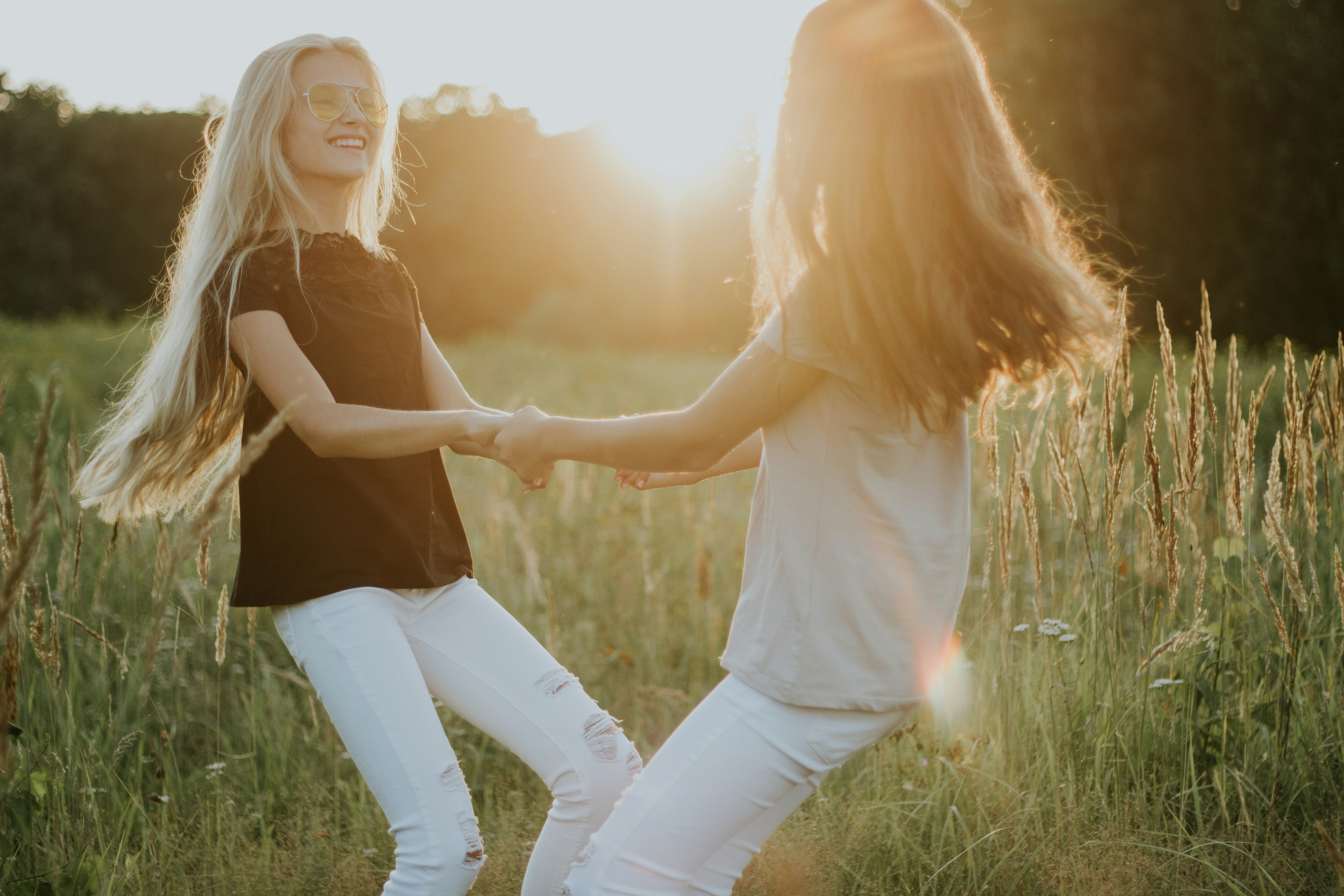 Sunlit Laughs in a Meadow: A Duo Glimpse of Movement and Light