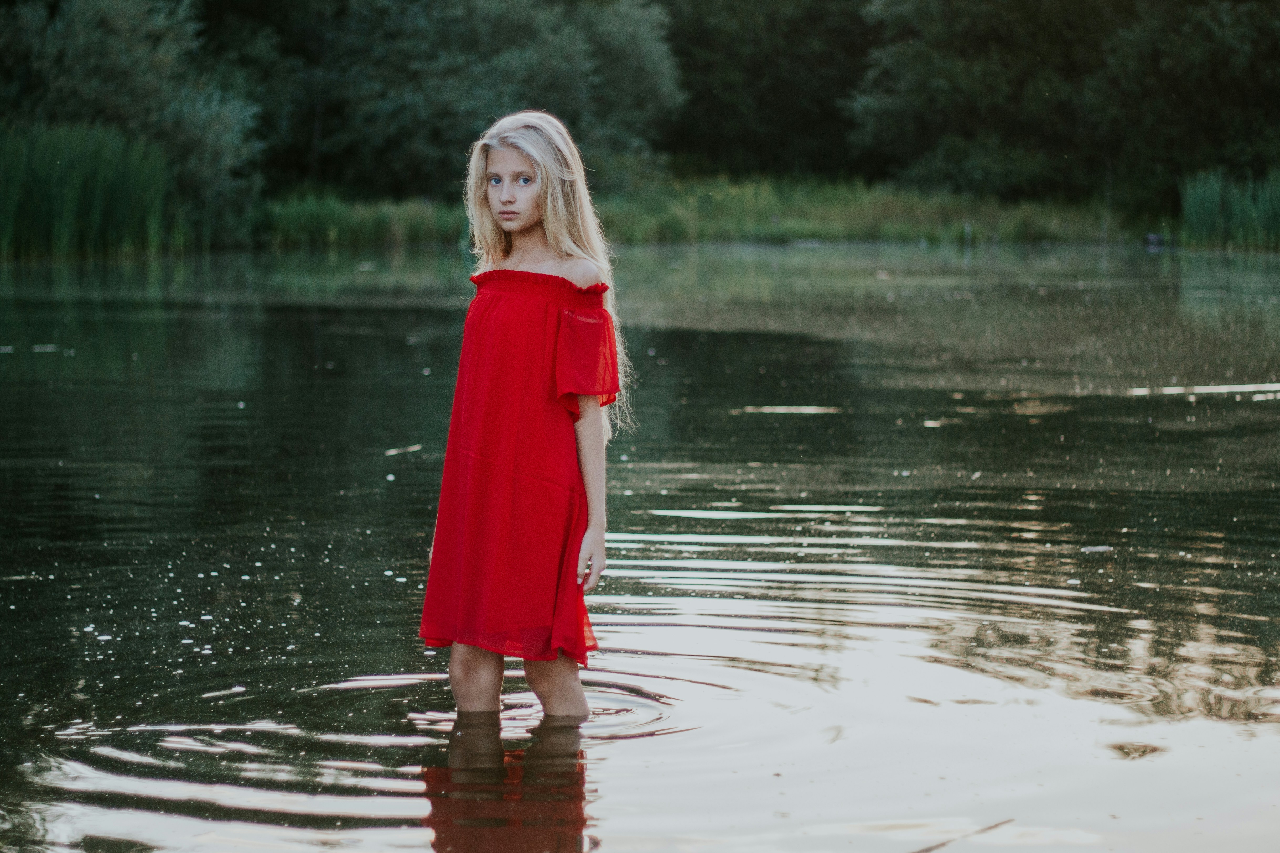 Red Dress in the Water: A Quiet Portrait at the River Edge