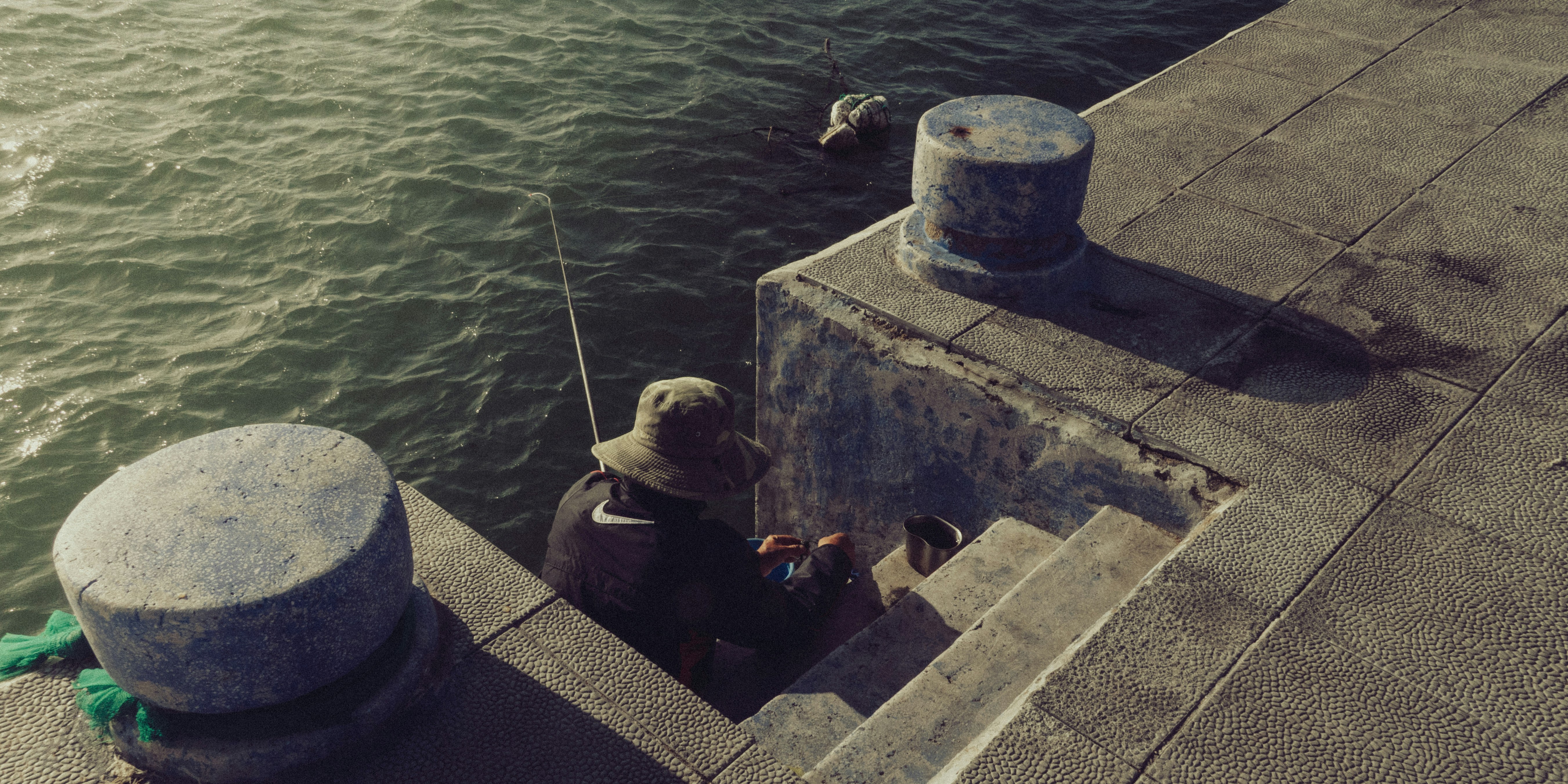 Quiet Angler at the Edge: A Pier Portrait