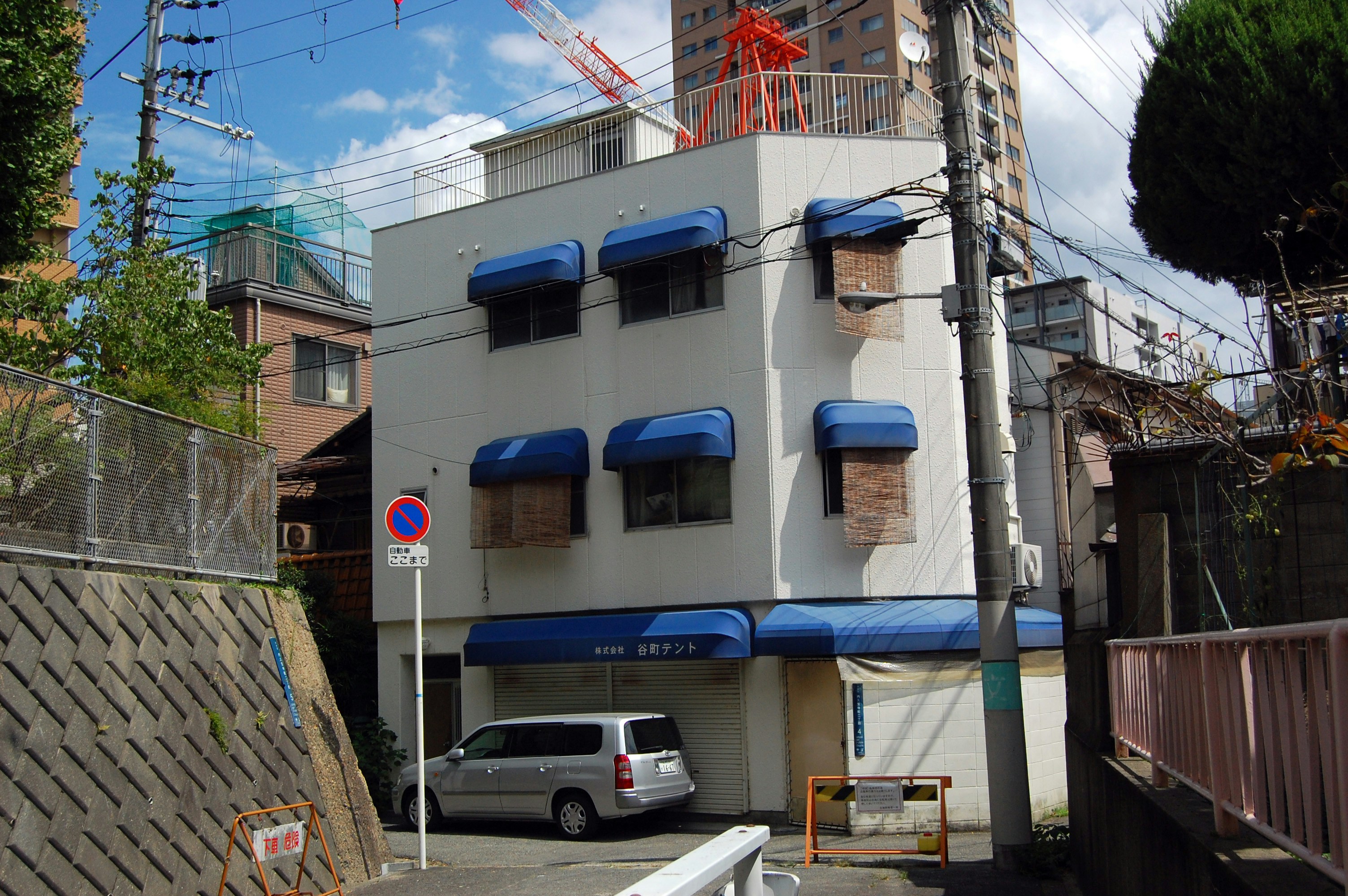Blue Awns on a Quiet Urban Facade
