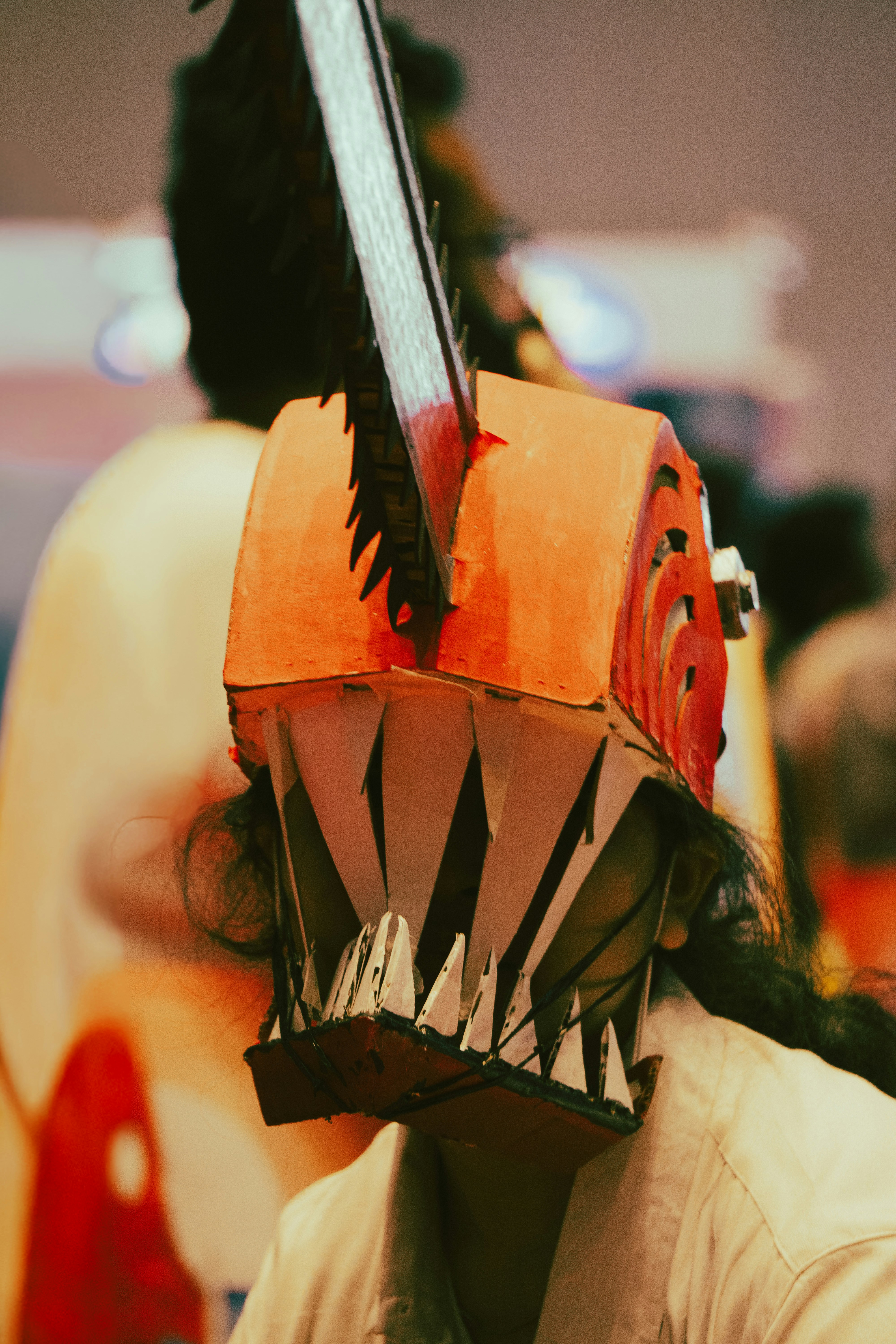 Person wearing a chainsaw mask with sharp teeth