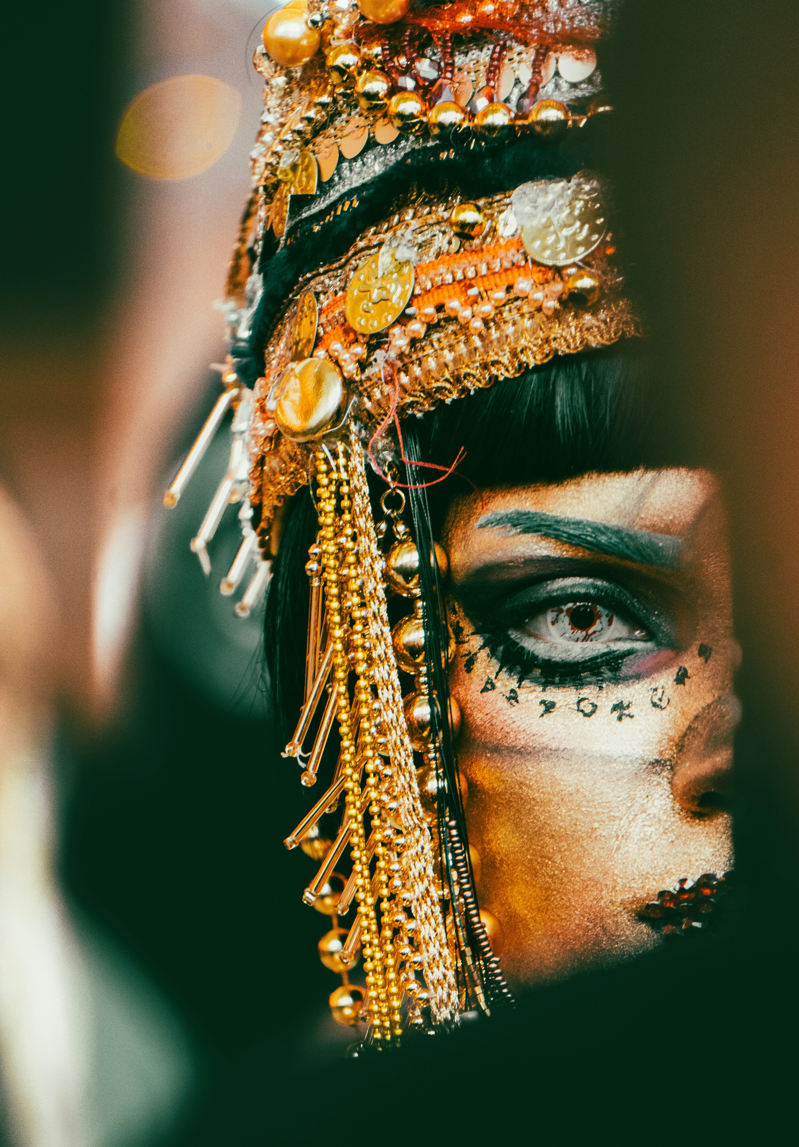 Gilded Beauty: An Eye Aglow Beneath Ornate Headdress