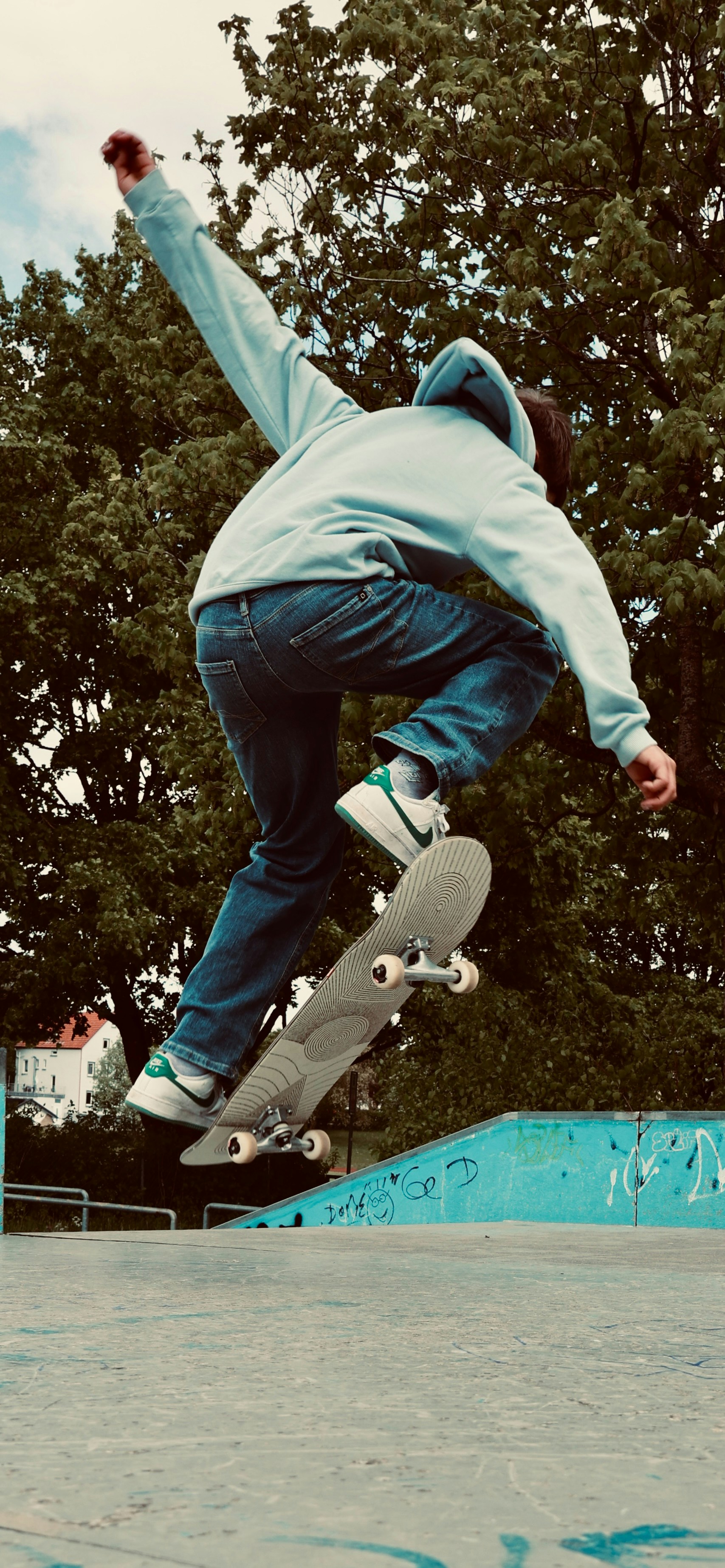 Leap of Momentum: Skateboarder in Mid-Flight at the Skater Park