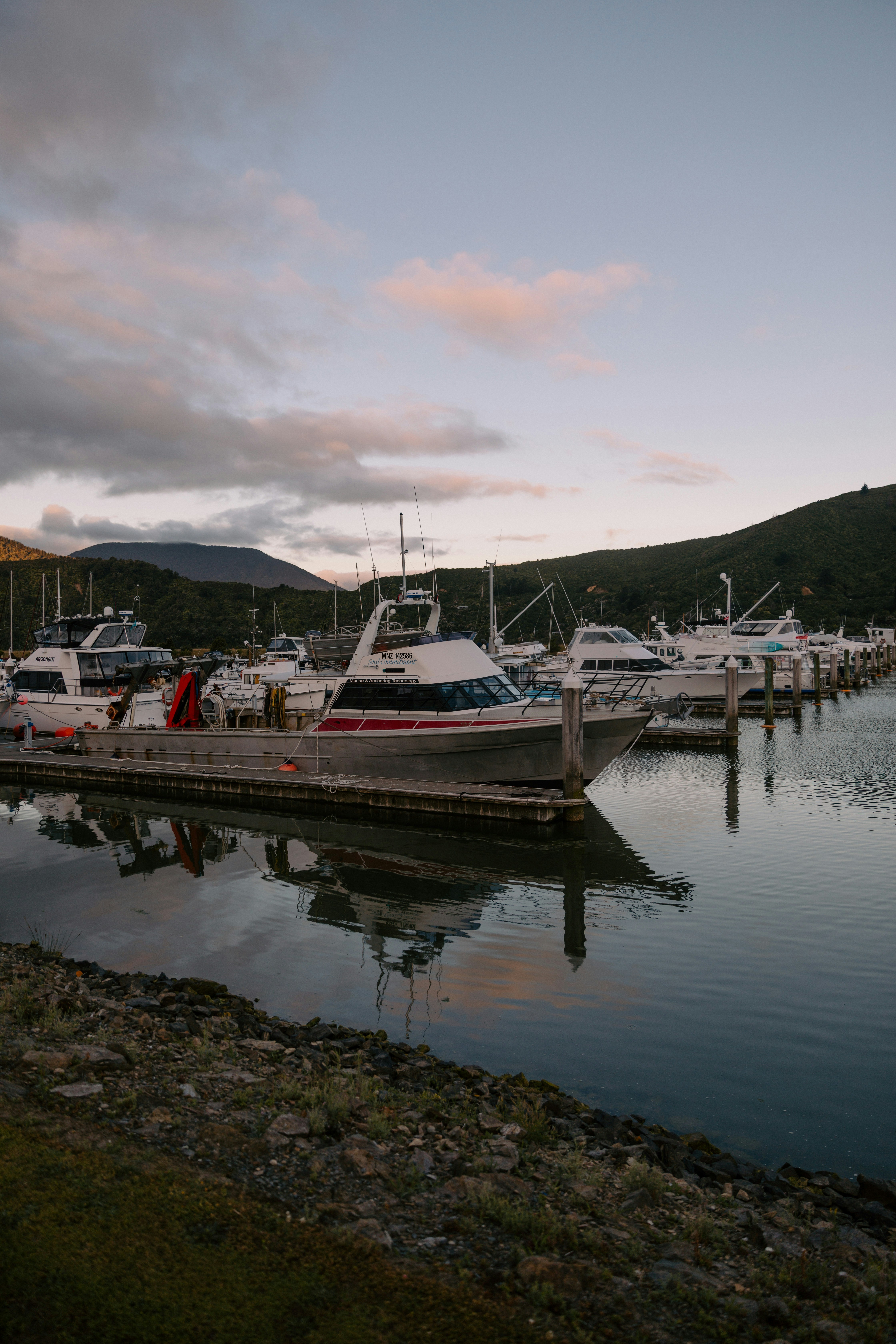 Harbor Quiet: Boats Rest Along a Sunset-Draped Dock