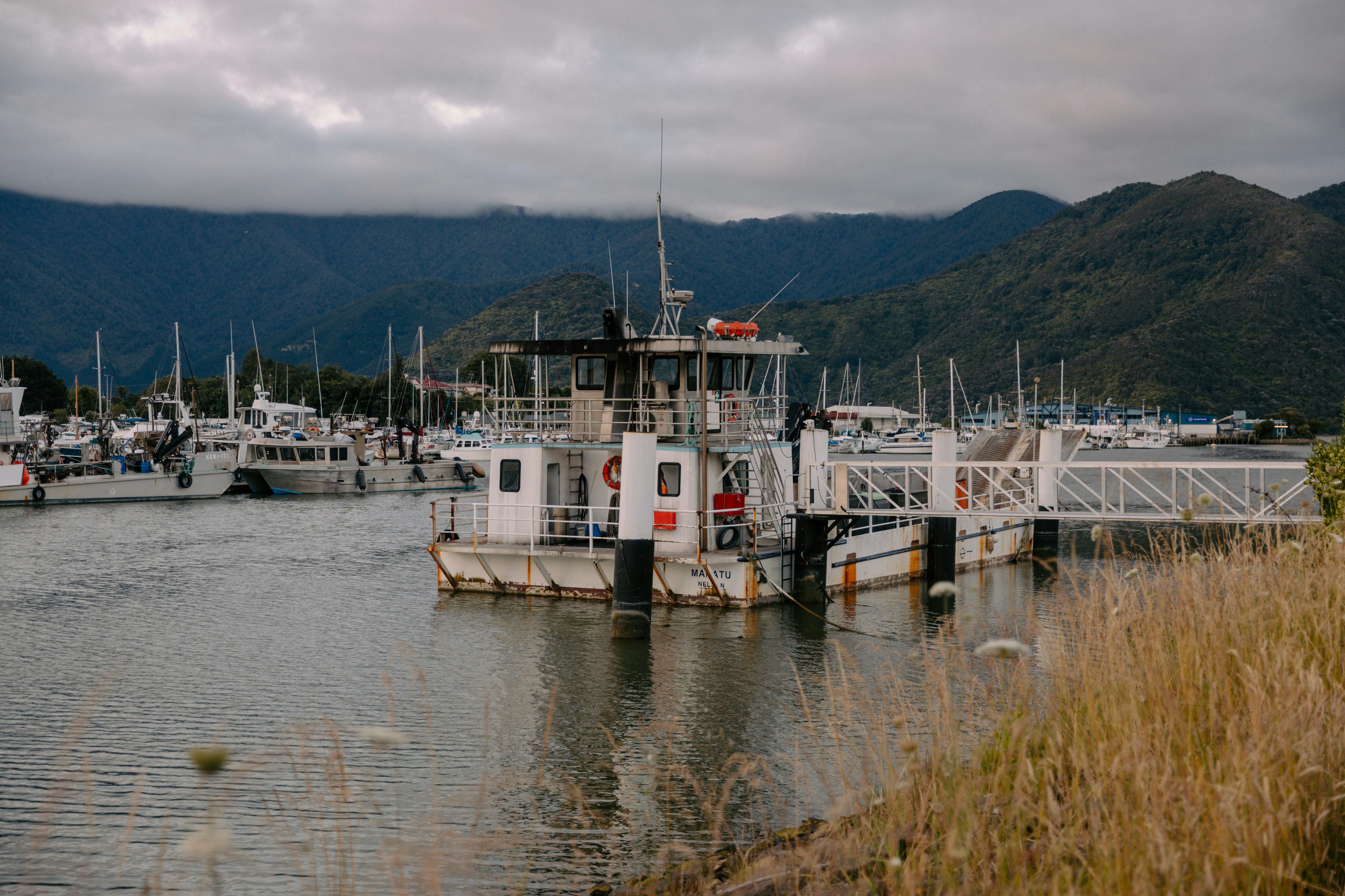Docked Quiet: Boats at Rest with Mountain Backdrop