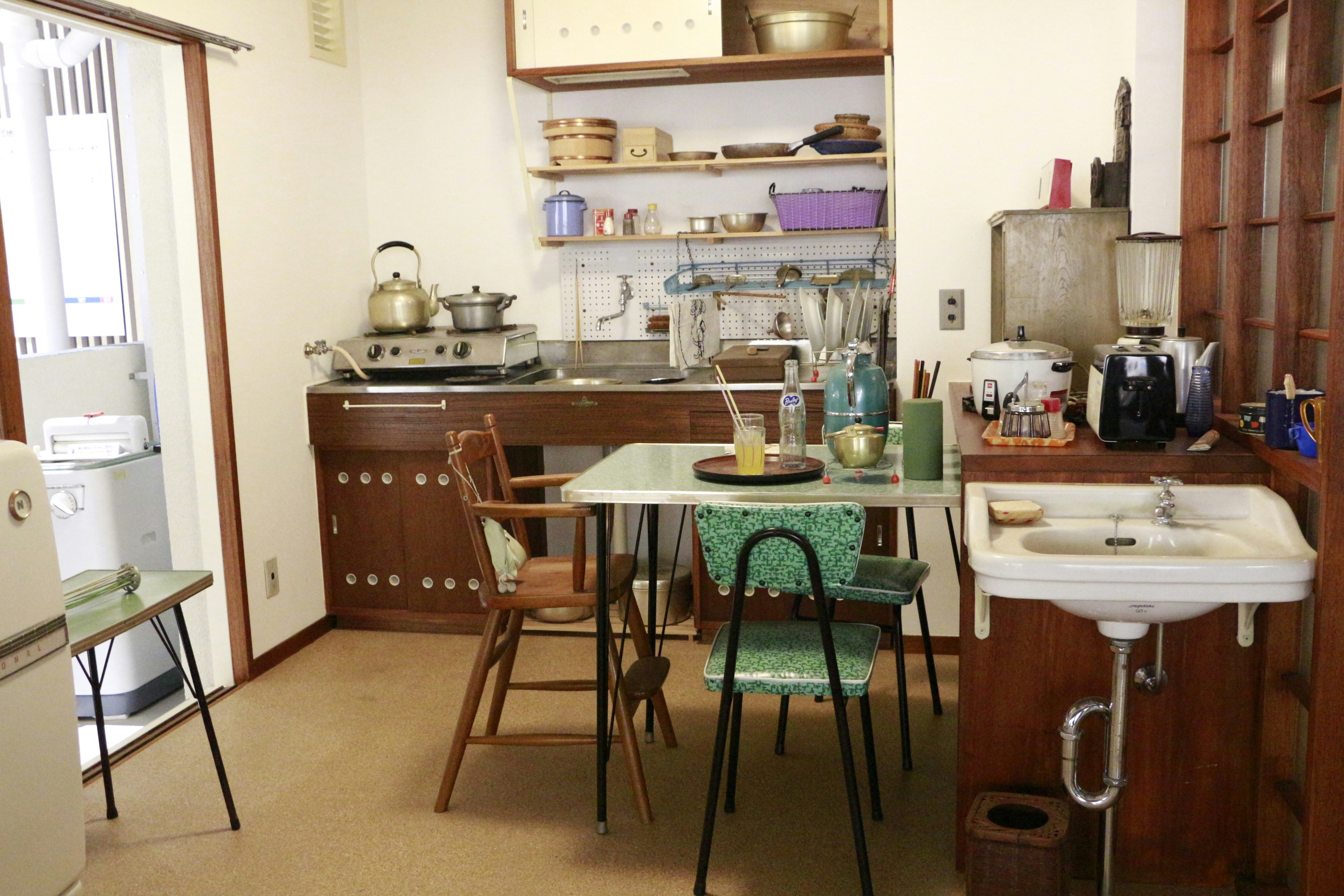 Cozy retro-kitchen still life with compact dining and utility sink