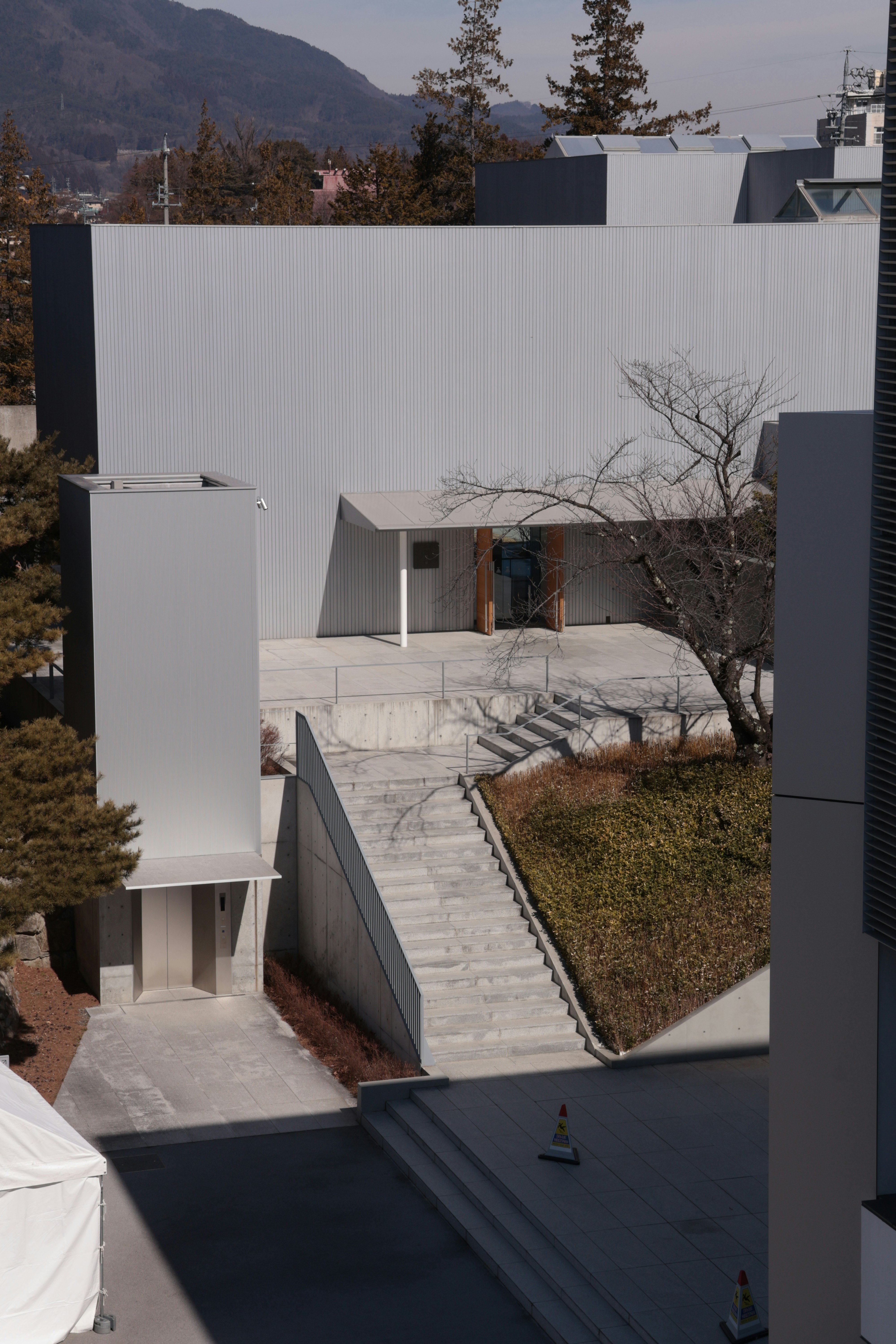 Concrete Staircase Bridging Levels in Quiet Campus Architecture