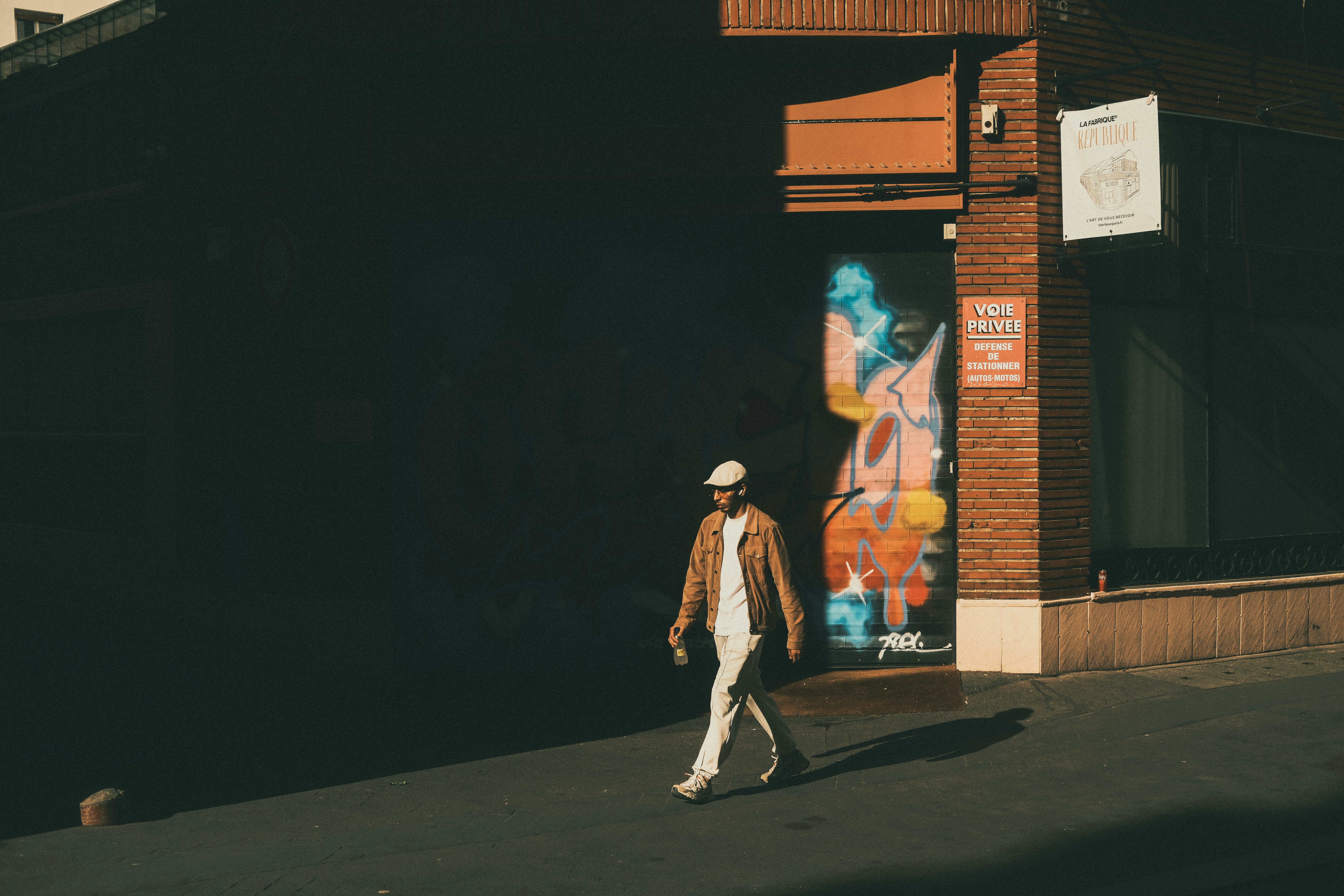 Striding through Shadow and Color: A Solo Figure in Neon Graffiti Light