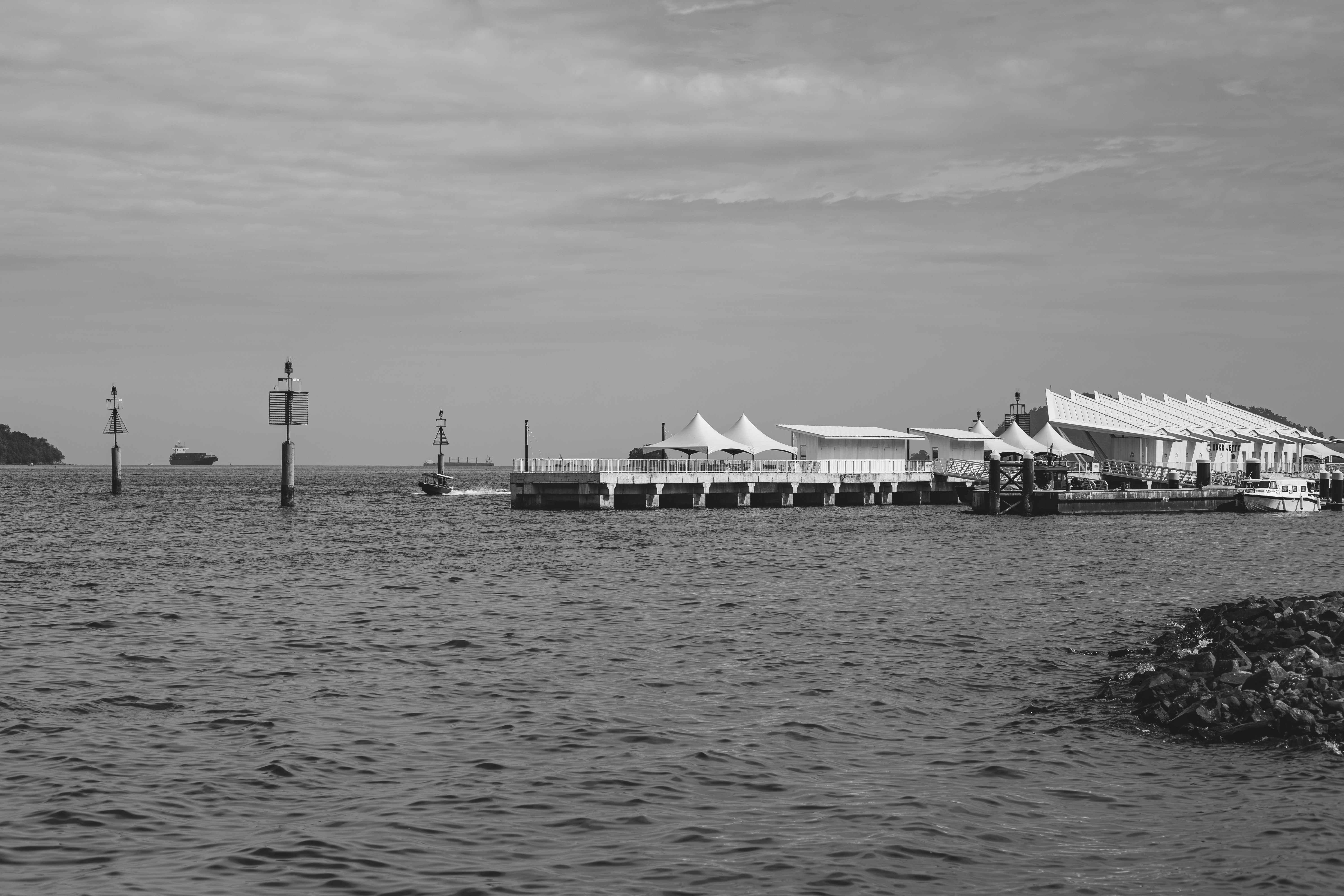 Harbor Approach: Docks and Tented Pier in Quiet Grayscale