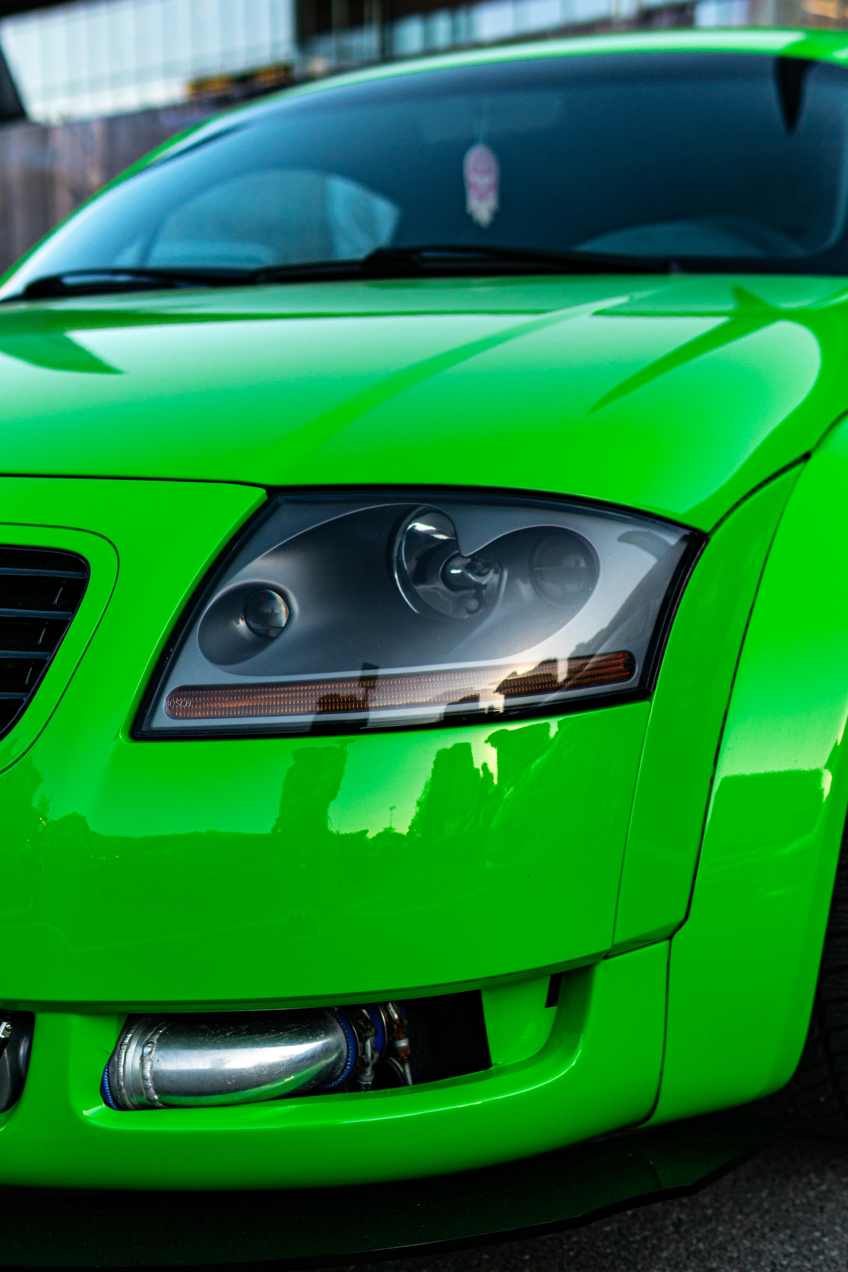 Neon Green Precision: A Car’s Aggressive Front in Focus