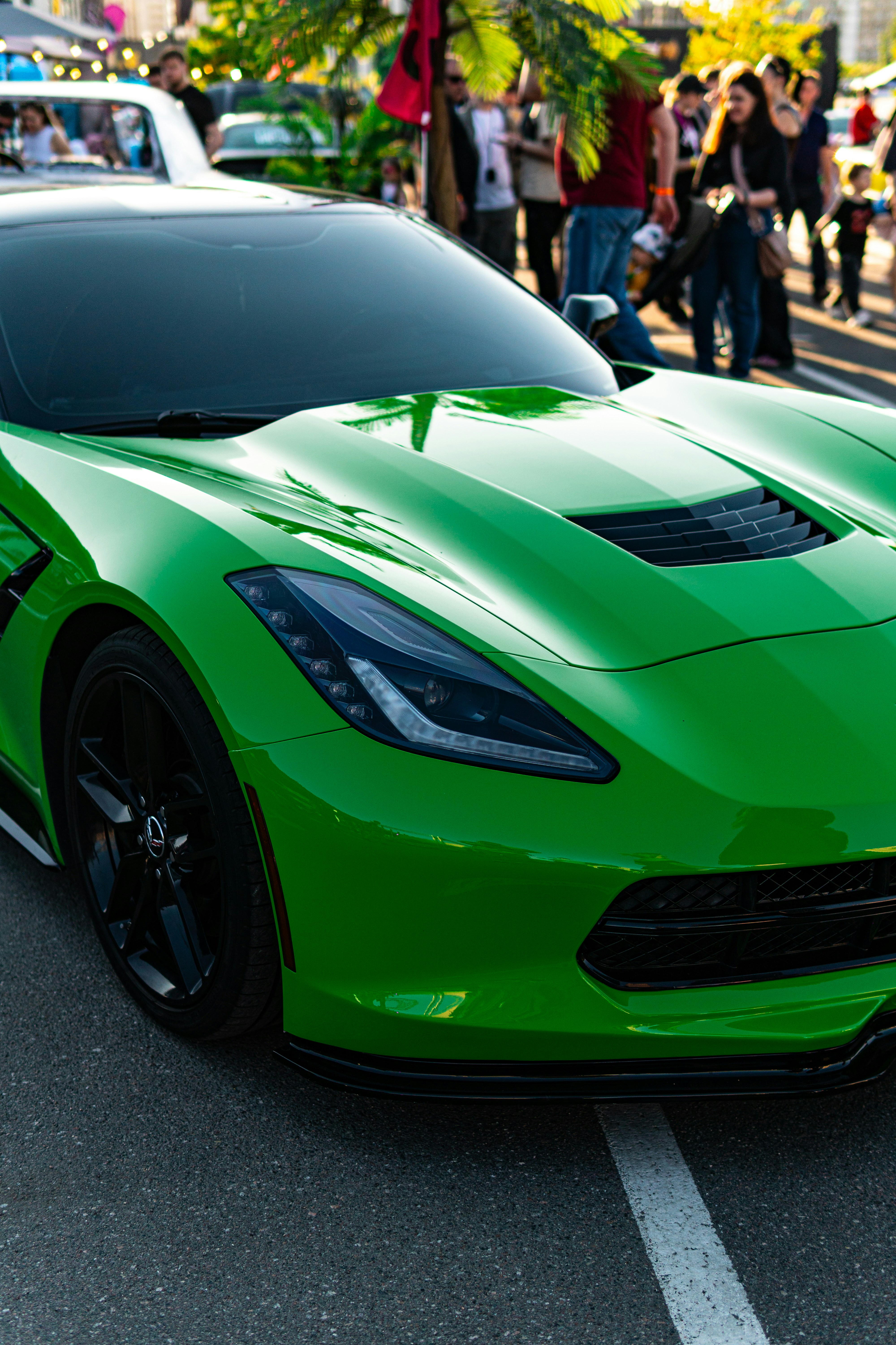 Neon-green muscle: a close-up on curves and chrome at a street car meet