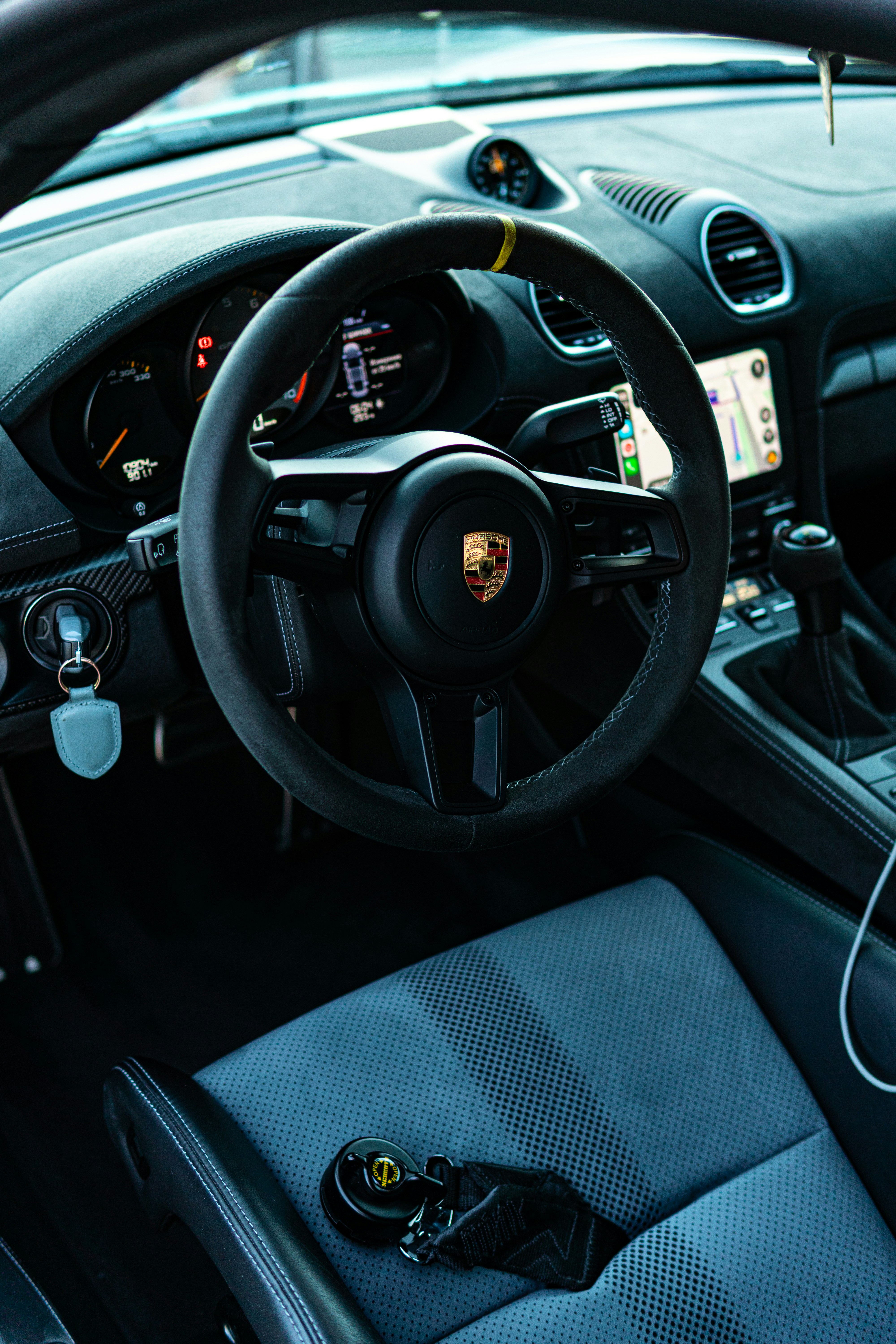 Steering Wheel with Porsche Emblem: Intimate Car Cabin Focus