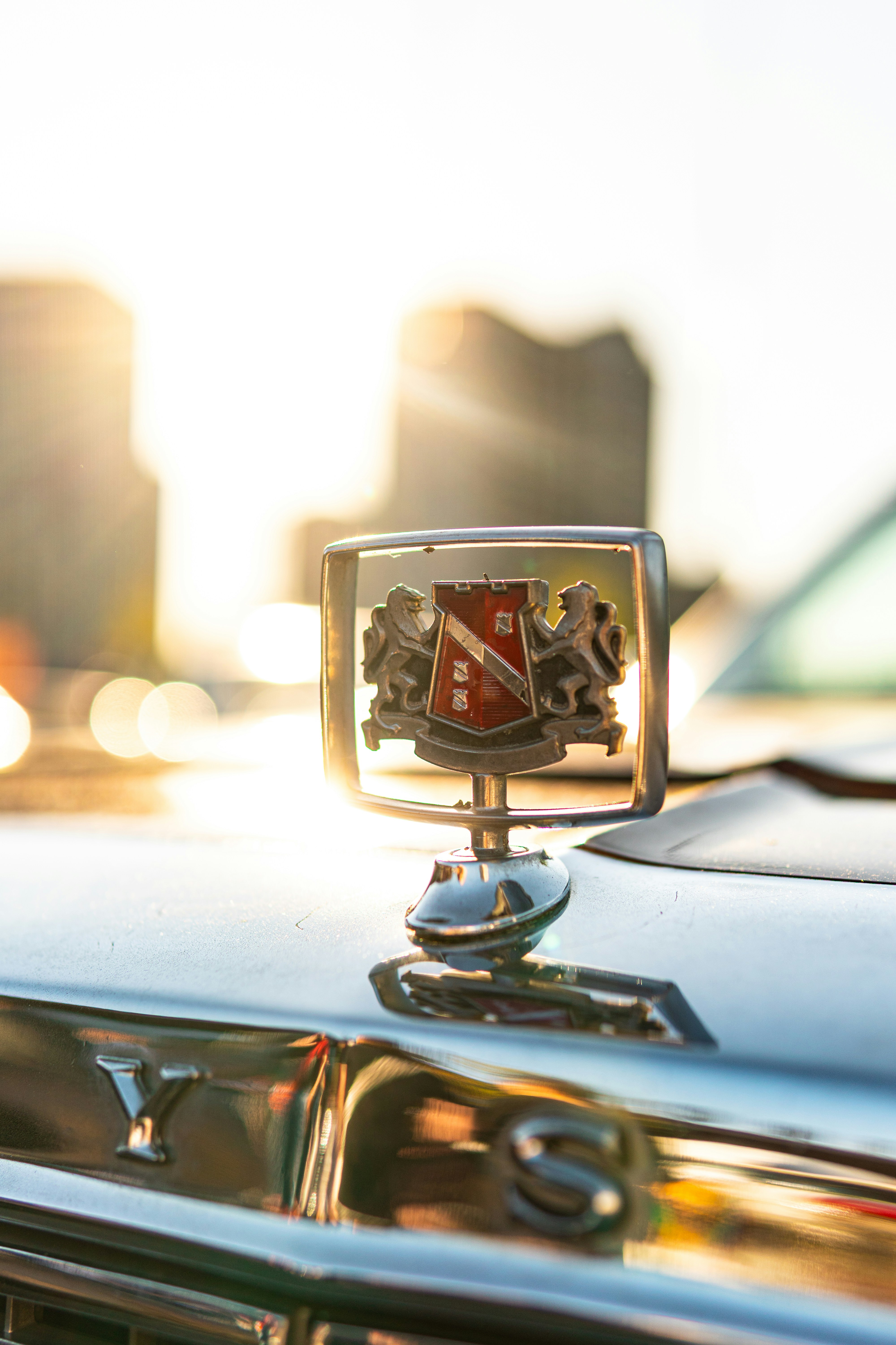 Hood Ornament Spotlight: Crest in the Car's Quiet Glow