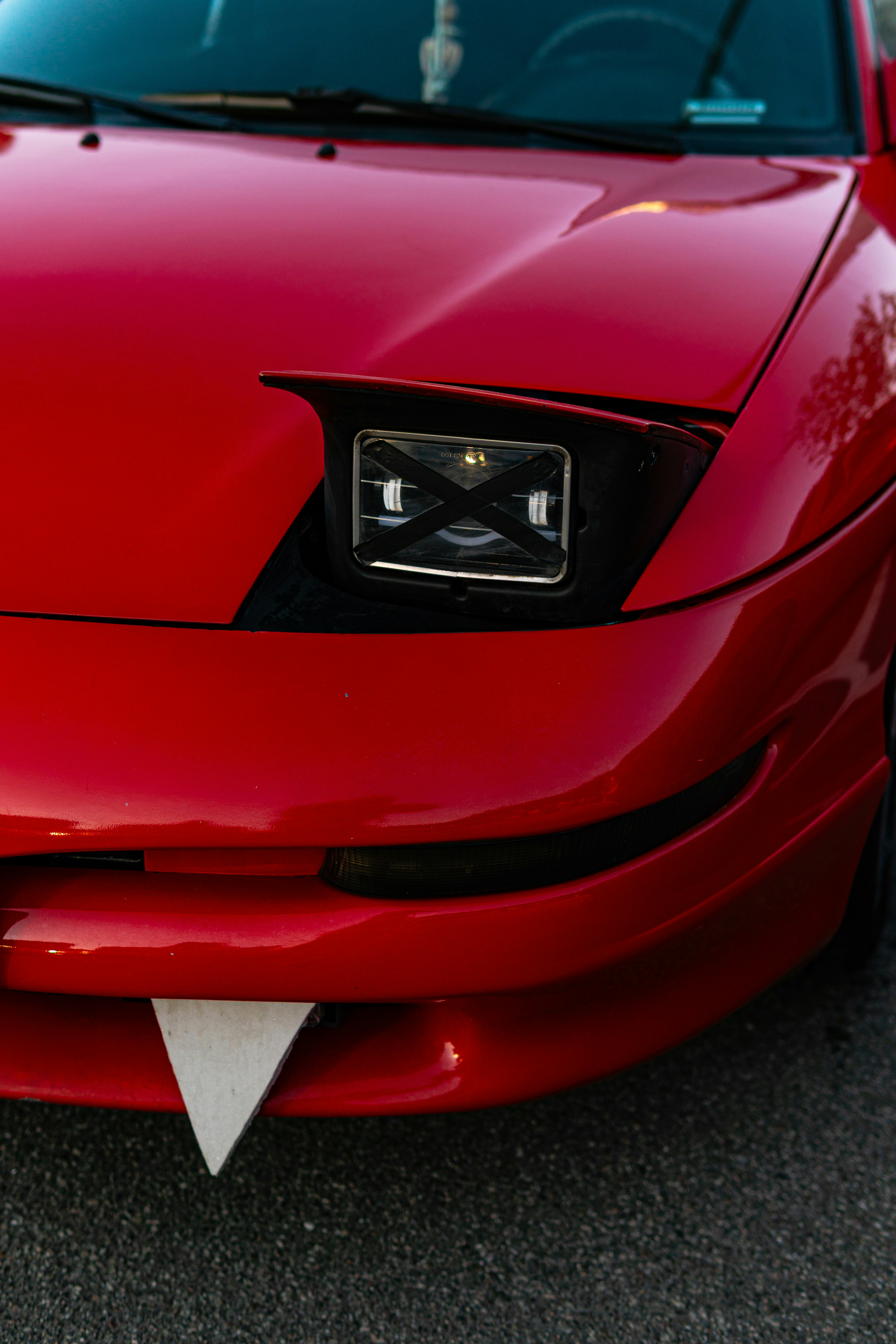 Red Arrowhead: The Car's Nose Confronts the Lens