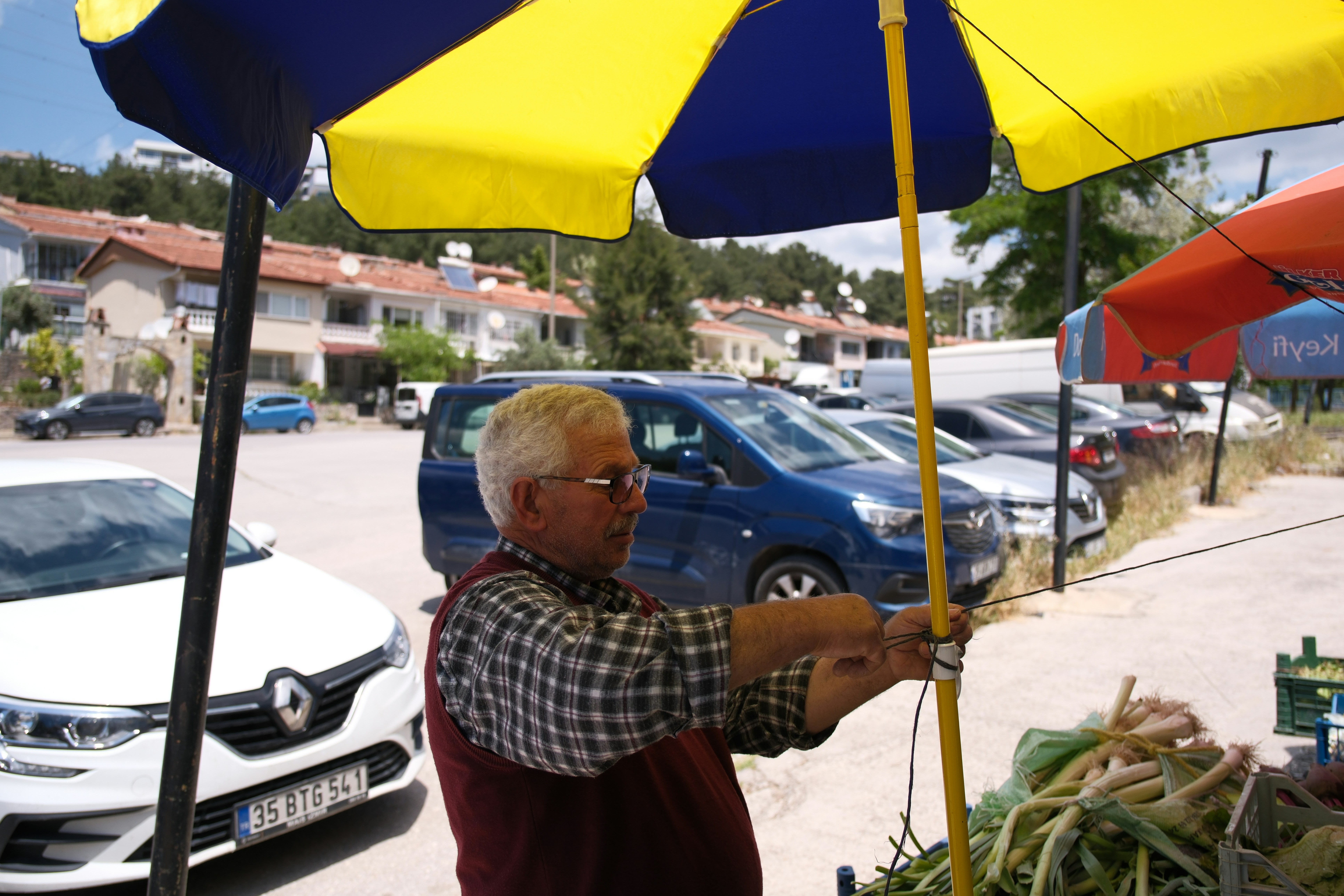 Market Vendor Under Bright Canopy Illuminates a Busy Street
