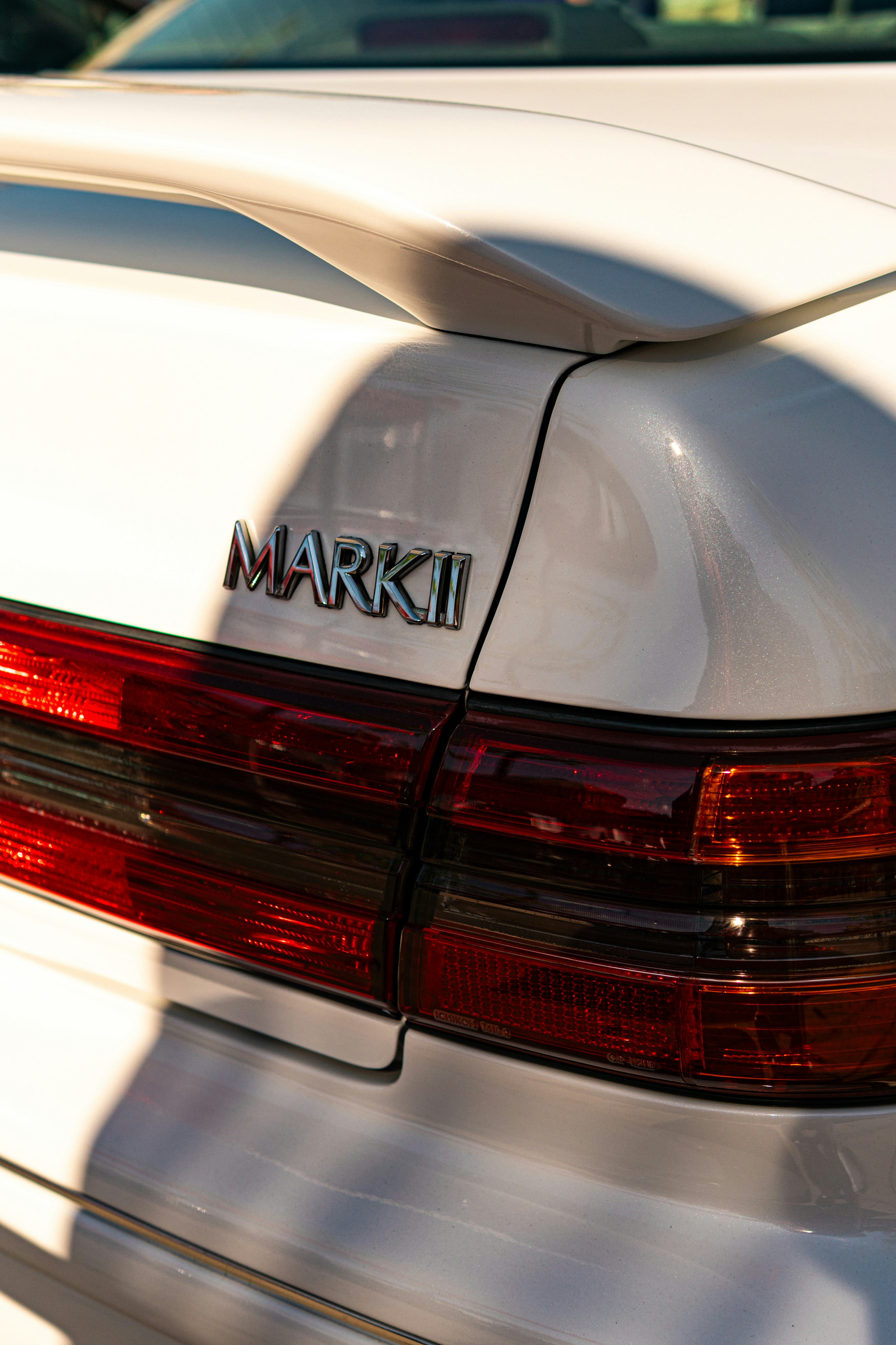 Tail Light and Badge in Afternoon Light on a White Mark II