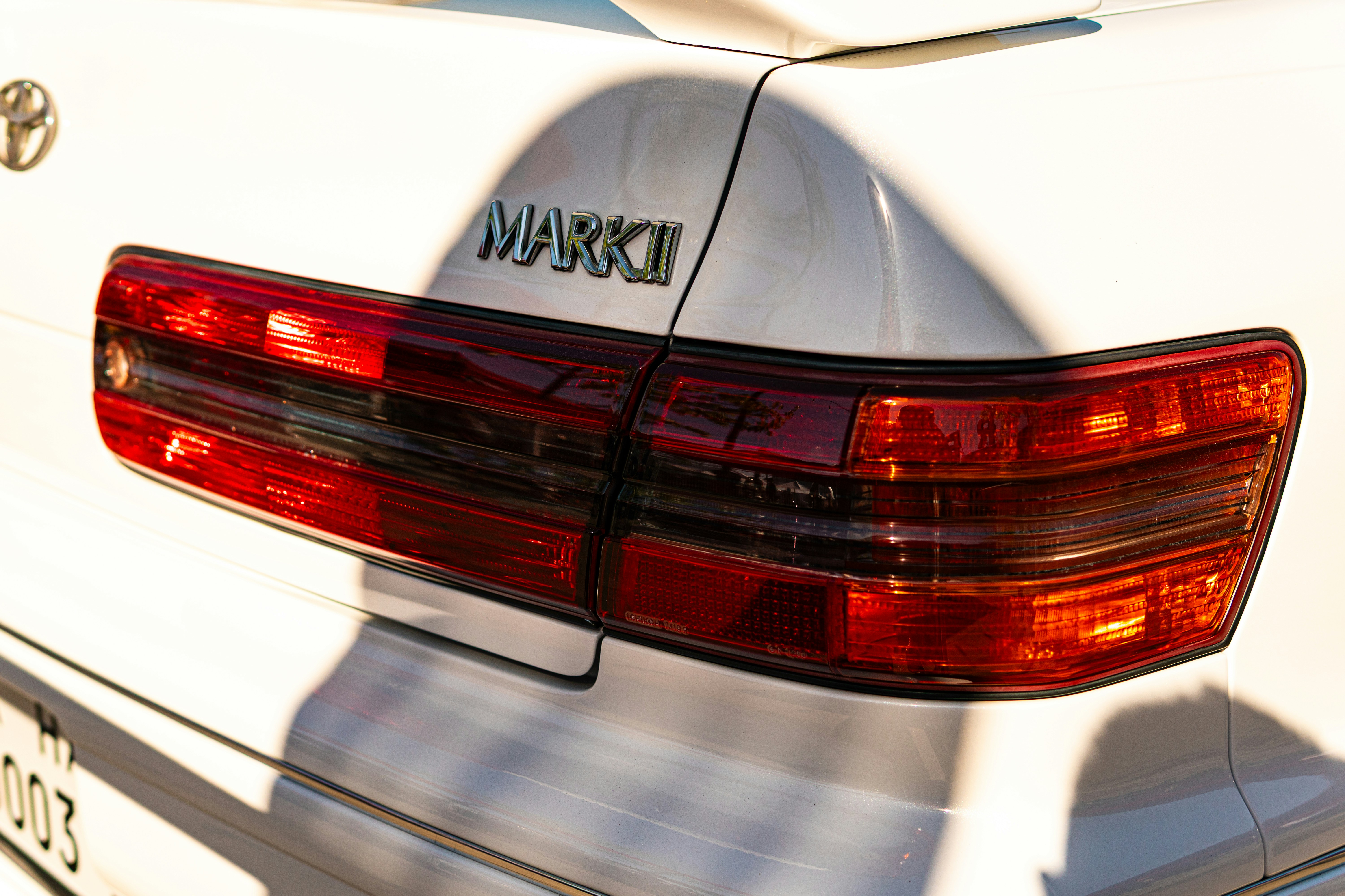 Tail Lights in Focus: A White Mark II Car in Bright Afternoon Light