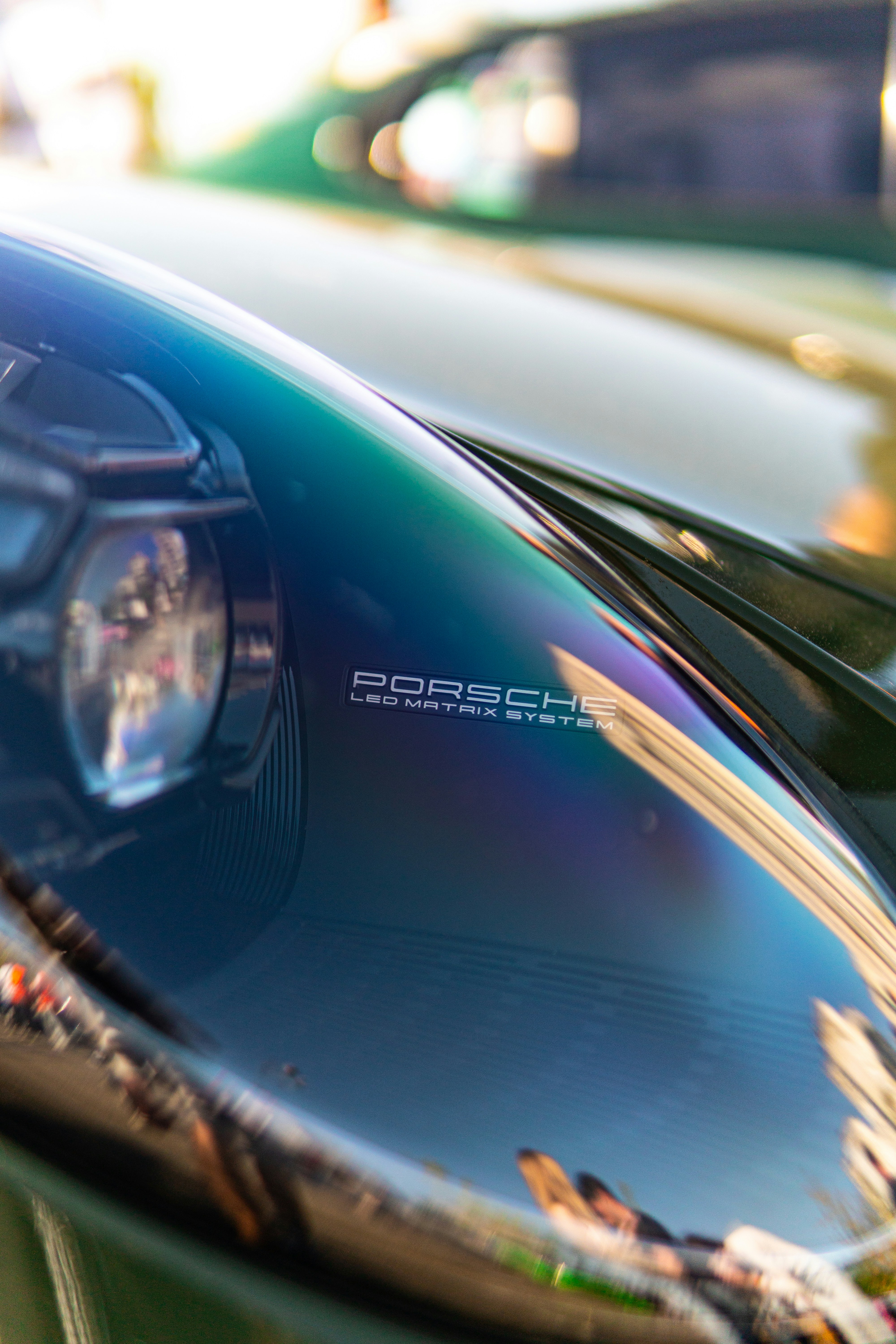 Porsche Crest Reflections: A Gleaming Close-Up