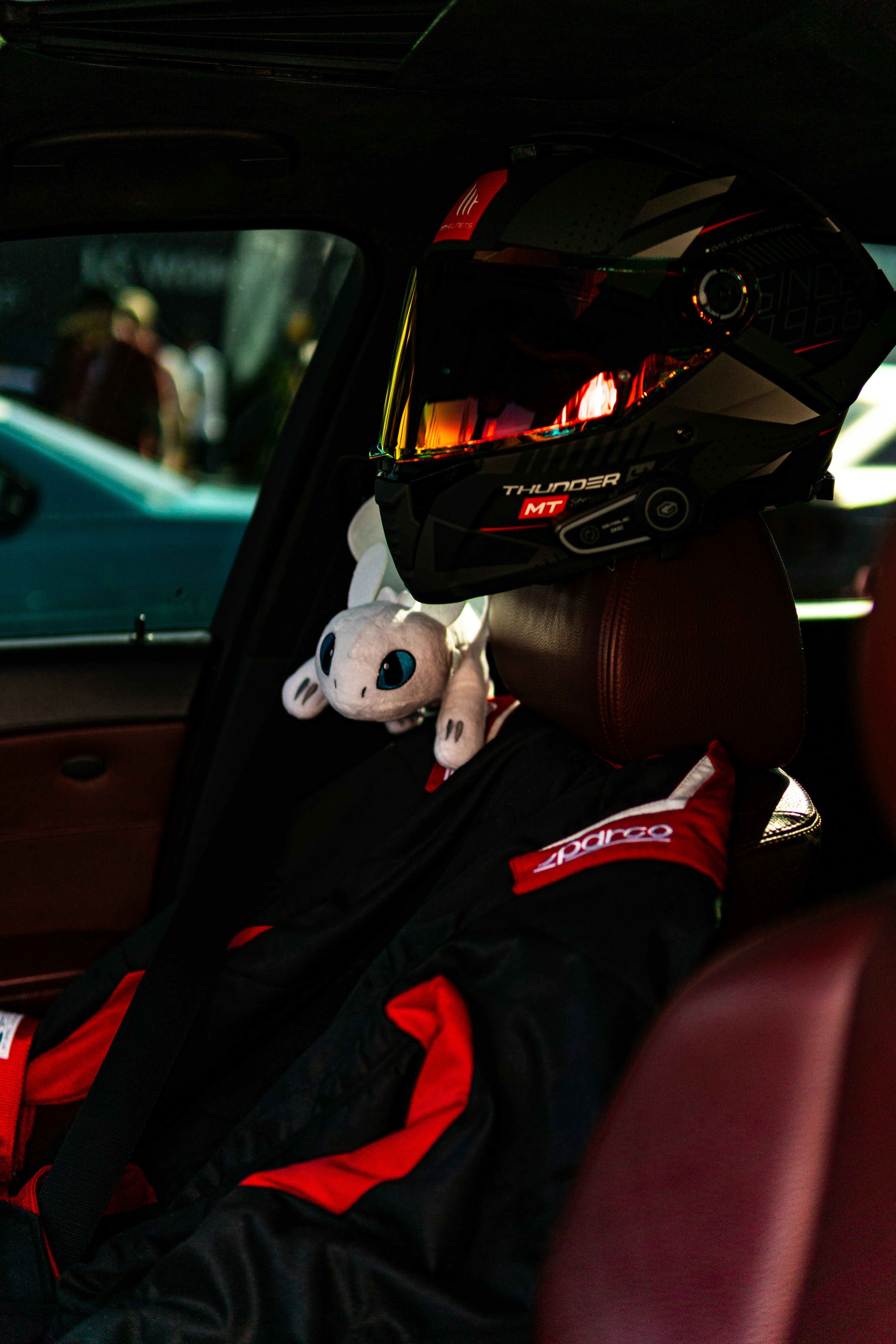 Helmeted Driver with Plush Co-pilot in Car Cabin