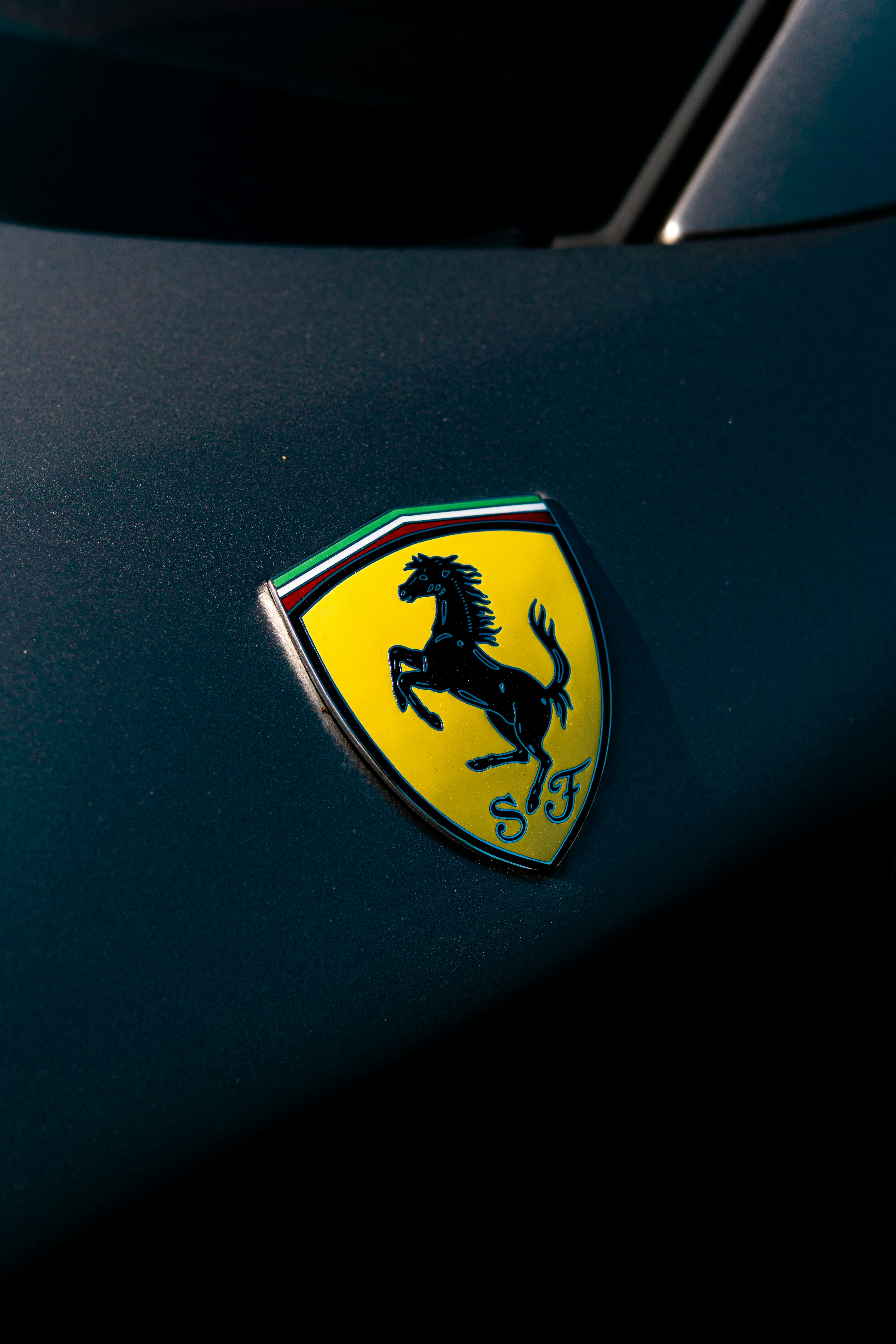 Prancing Emblem: Ferrari Crest on a Curved Hood